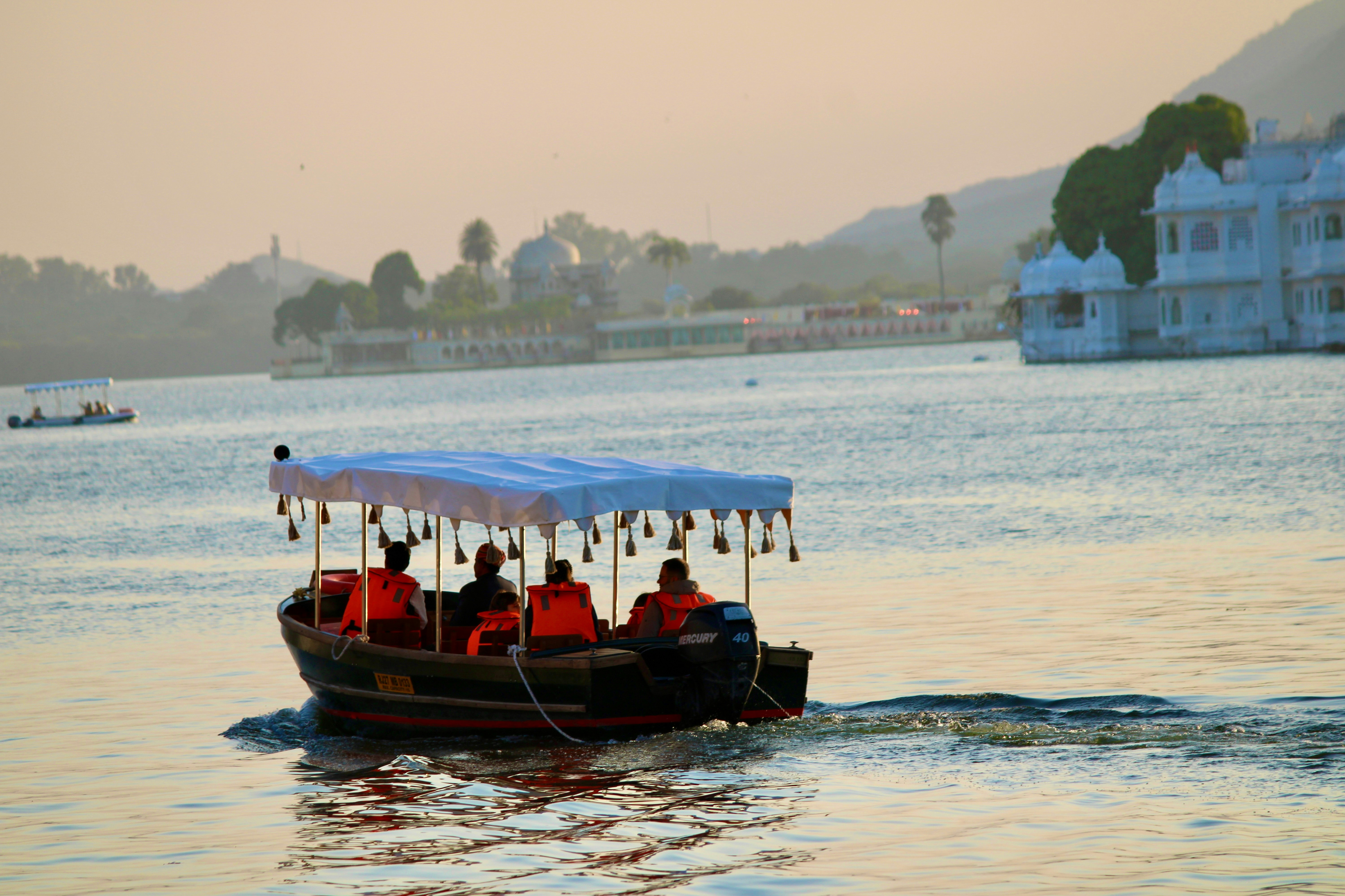 A group of people on a boat in the water photo – Free Gangaur ghat marg ...