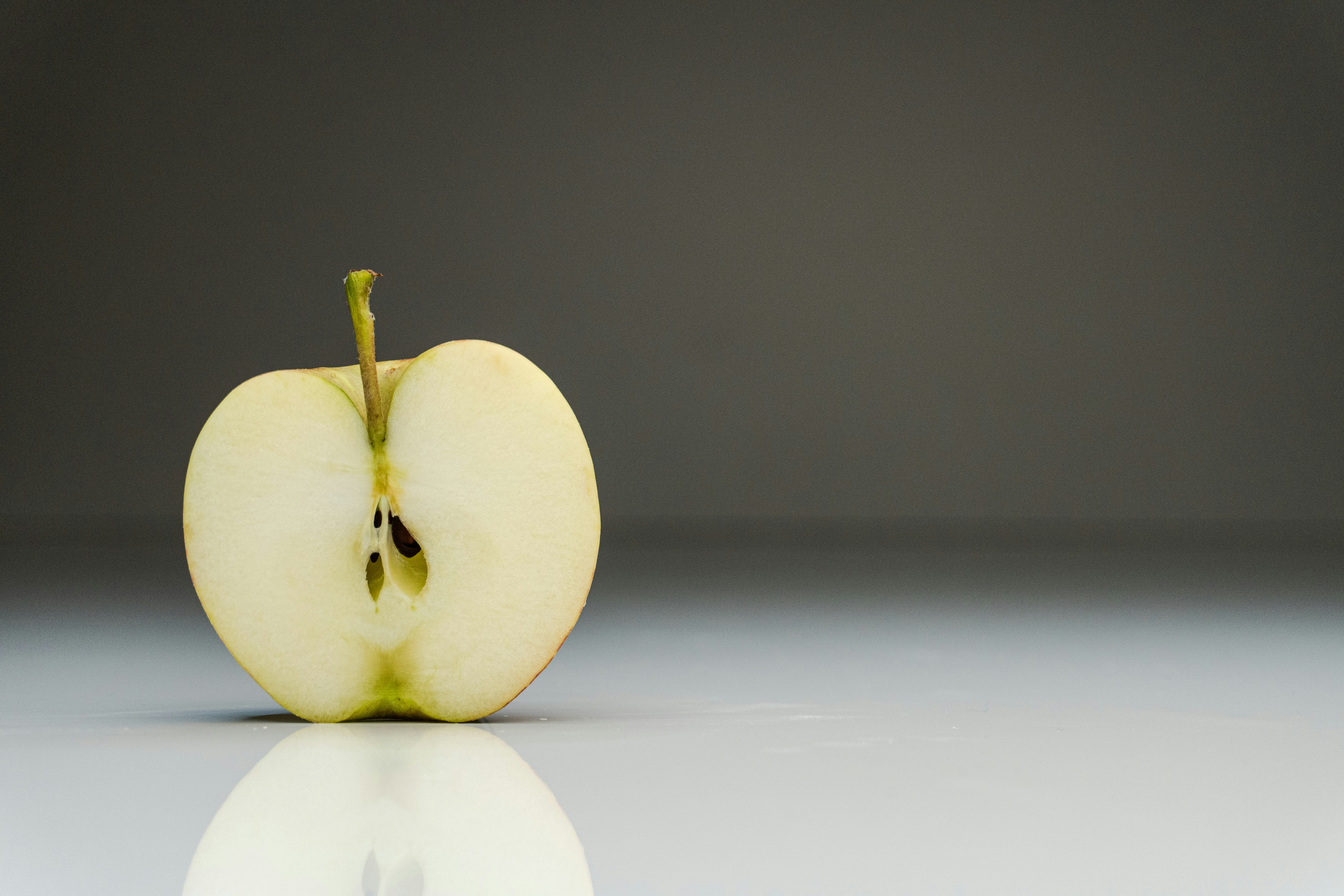 A half eaten apple sitting on top of a table photo – Free Apple Image ...