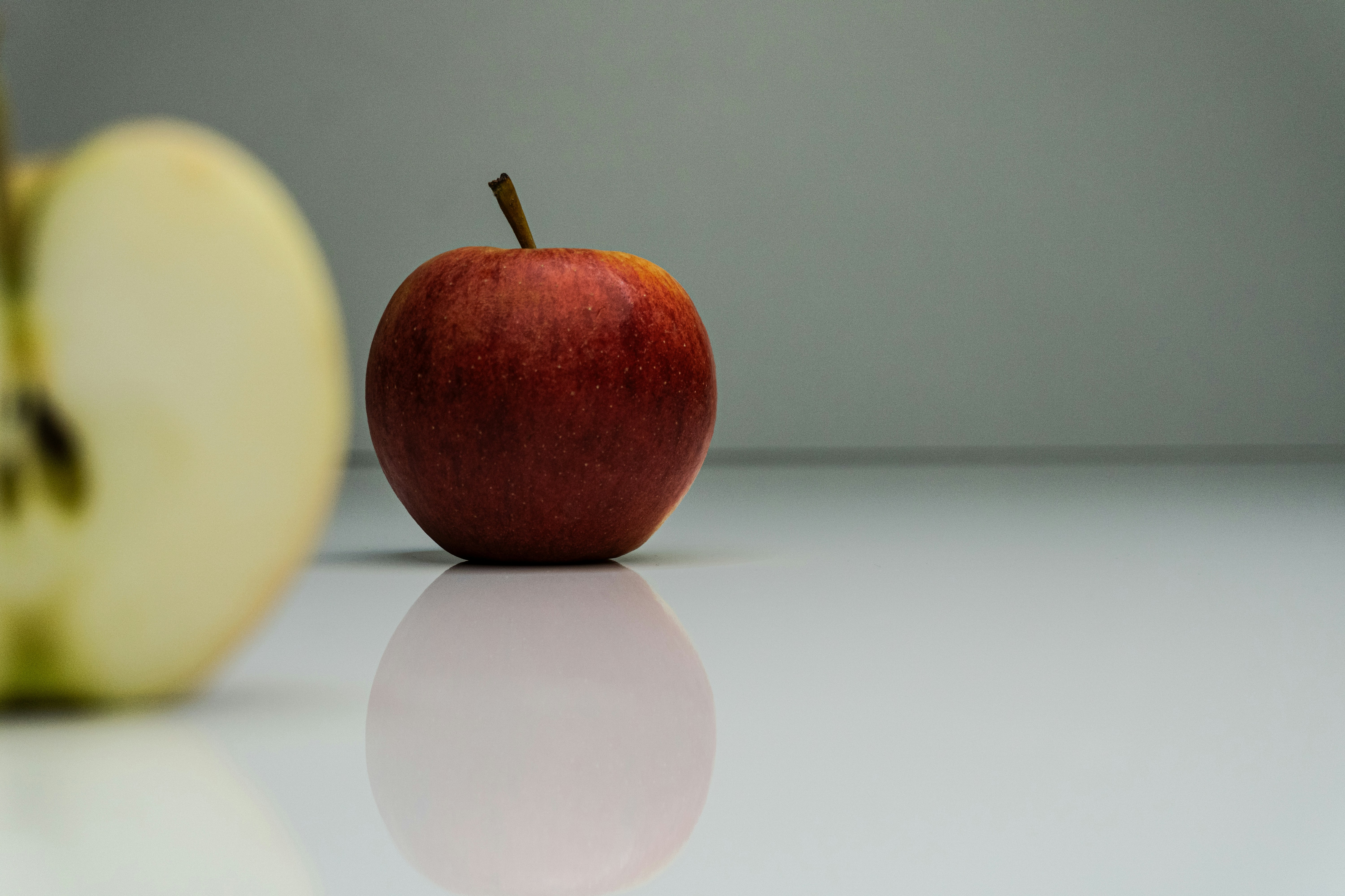 A red apple sitting next to a white apple photo – Free Apple Image on ...