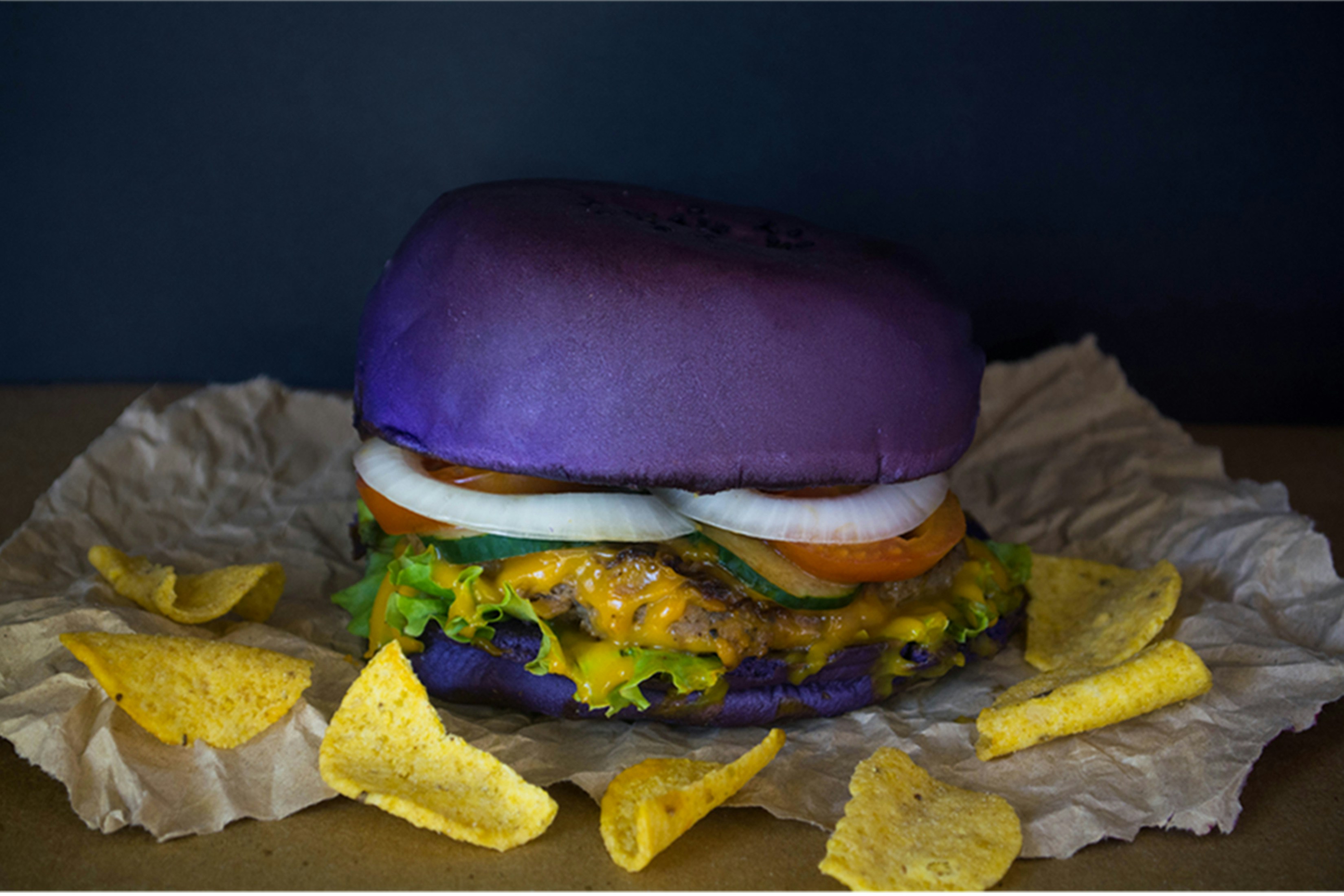 A hamburger with a purple bun and lettuce and cheese photo – Free ...