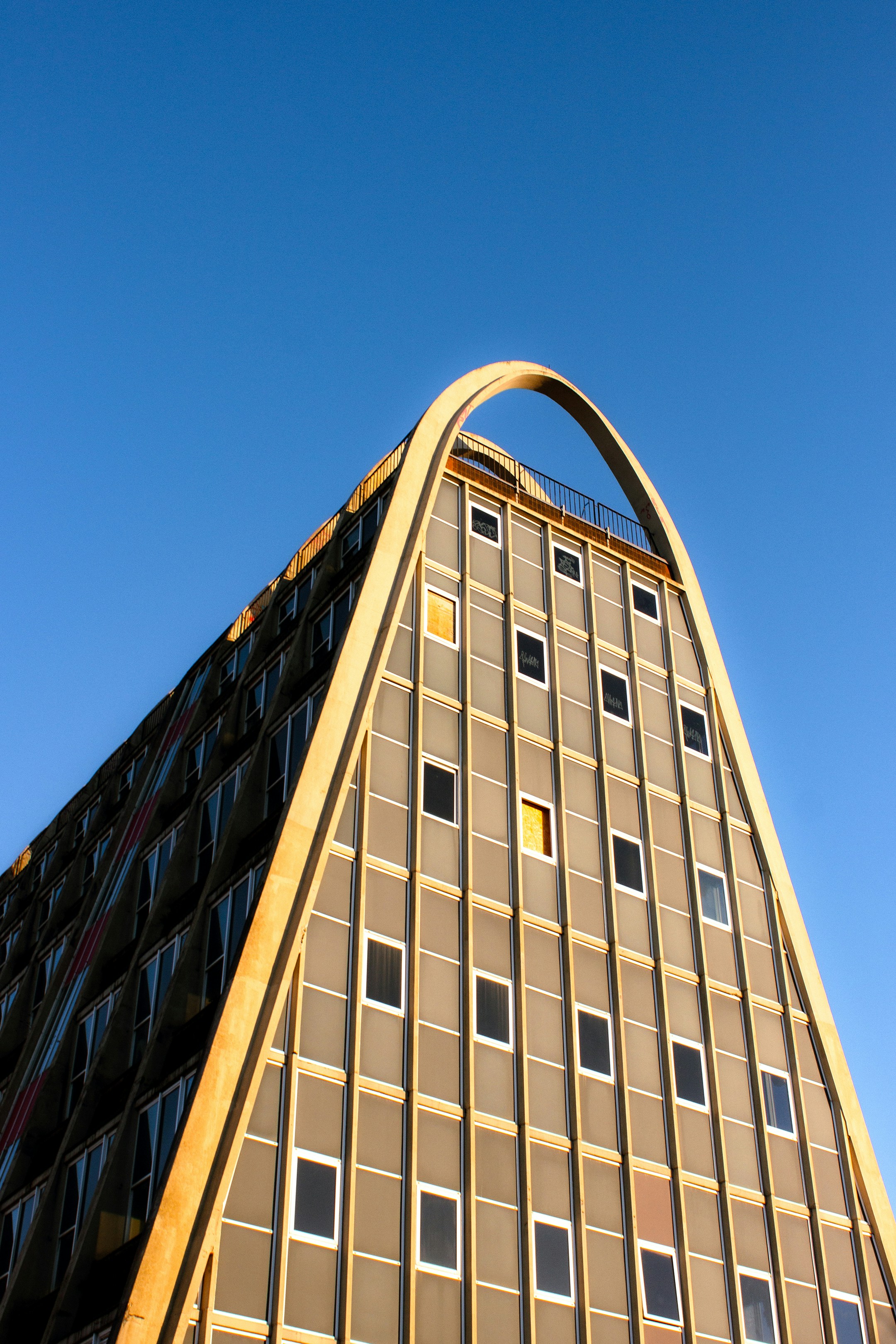 A very tall building with a very long curved roof photo – Free Uk Image ...