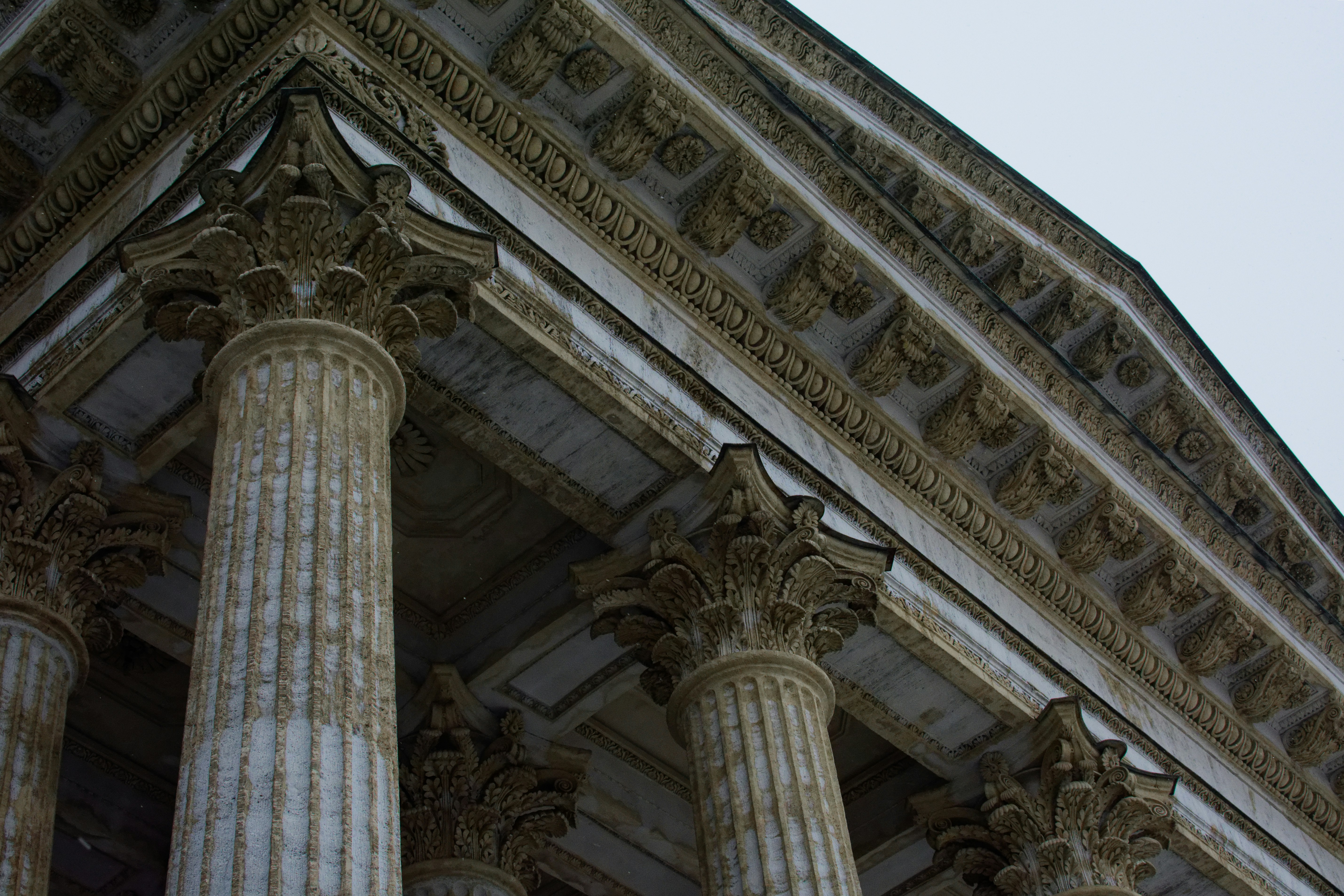 Classical building facade with ornate columns and detailed pediment.