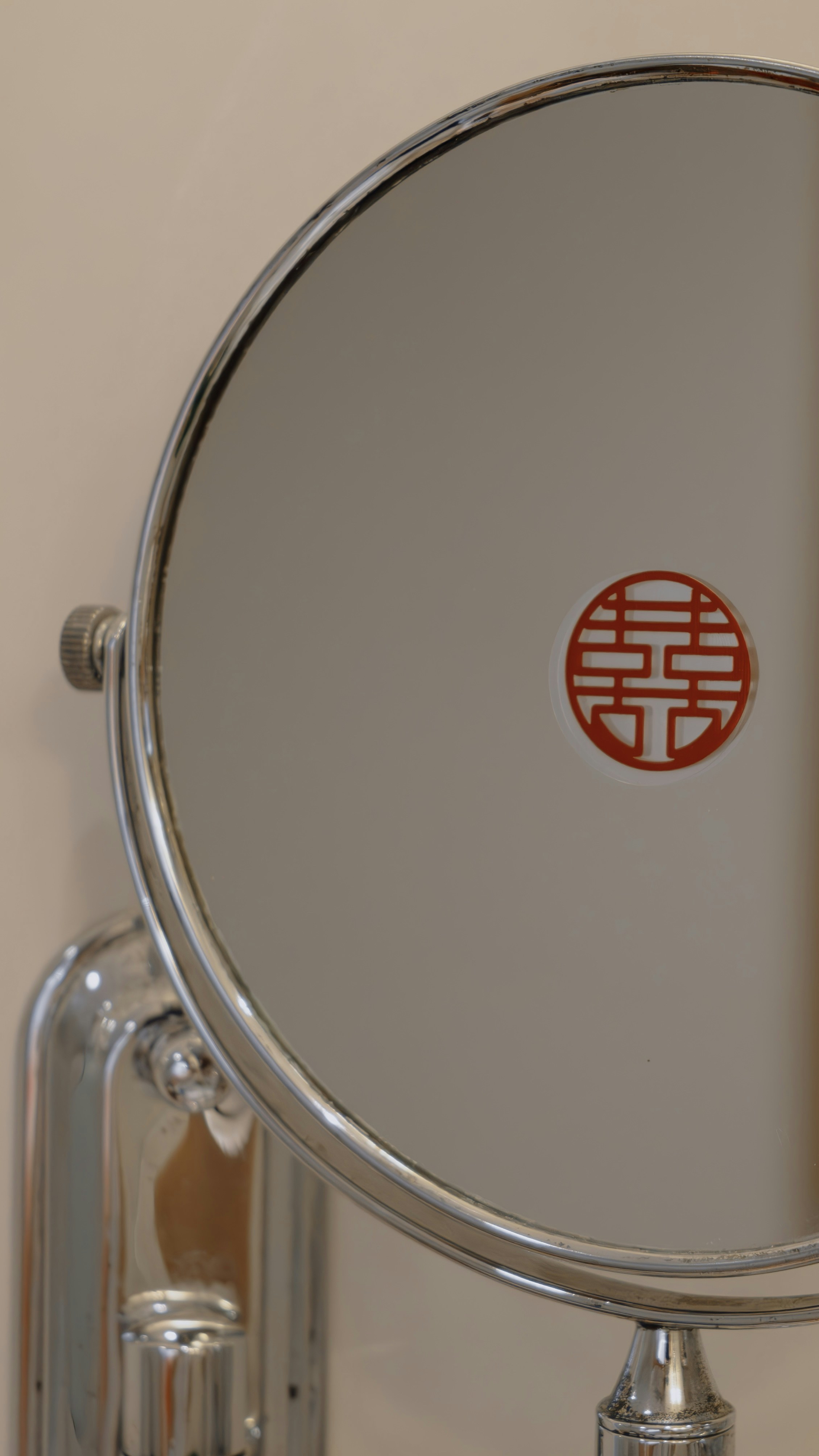 Chrome Circle: A Mirror with a Red Stamp of Quiet Precision