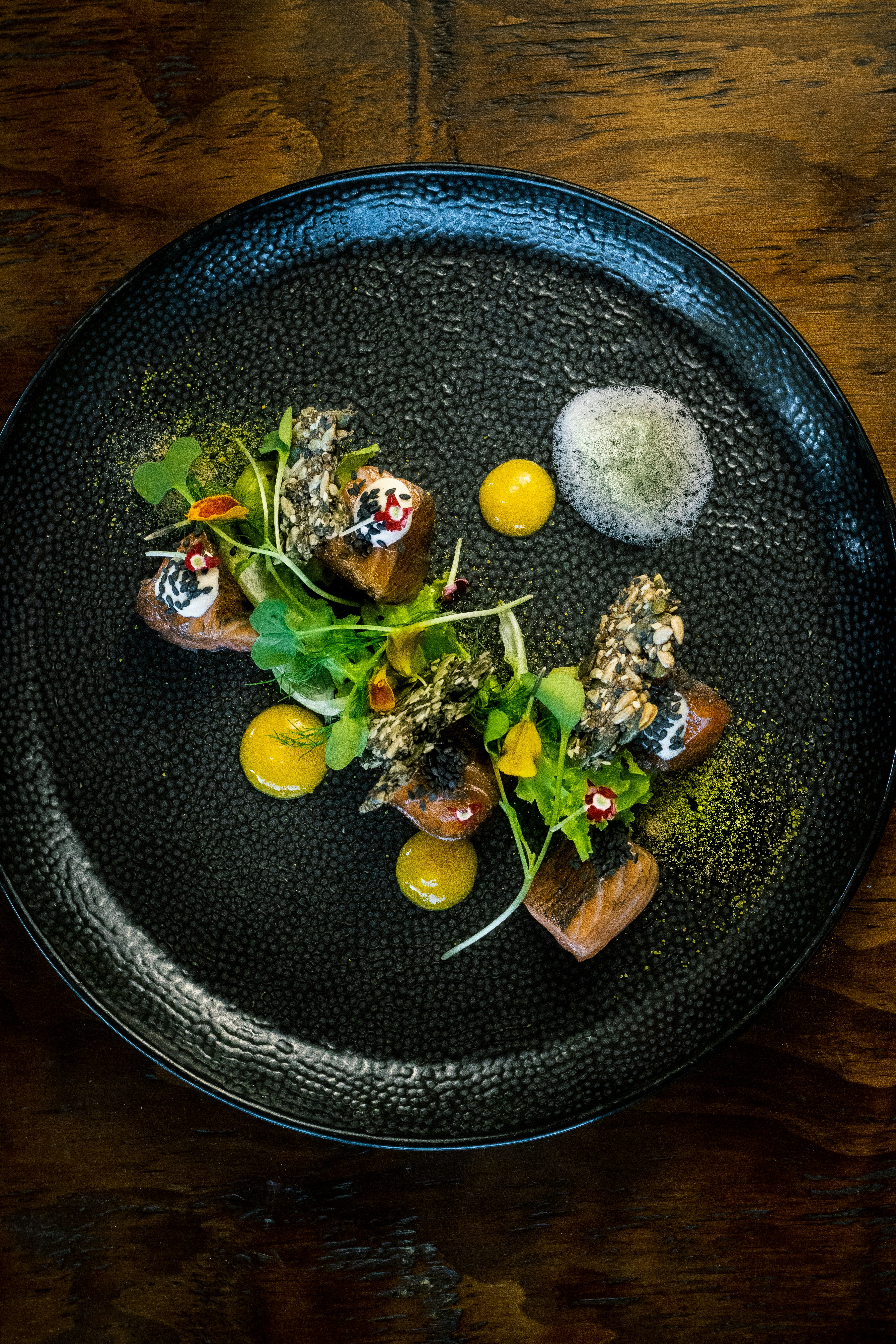 Salmon Mosaic with Microgreens and Golden Dollops on a Charcoal Plate