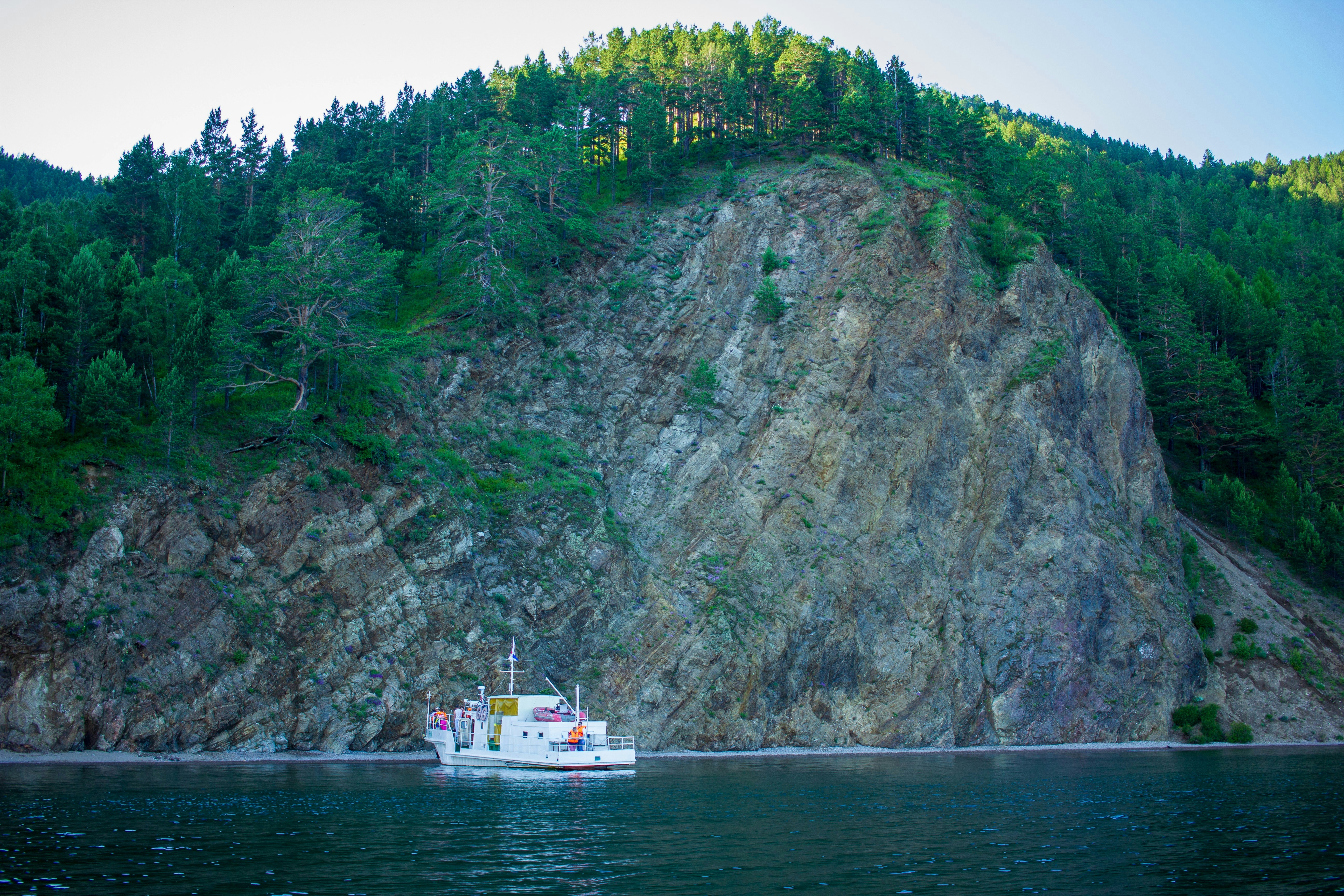 A boat on a body of water near a mountain photo – Free Irkutsk oblast ...