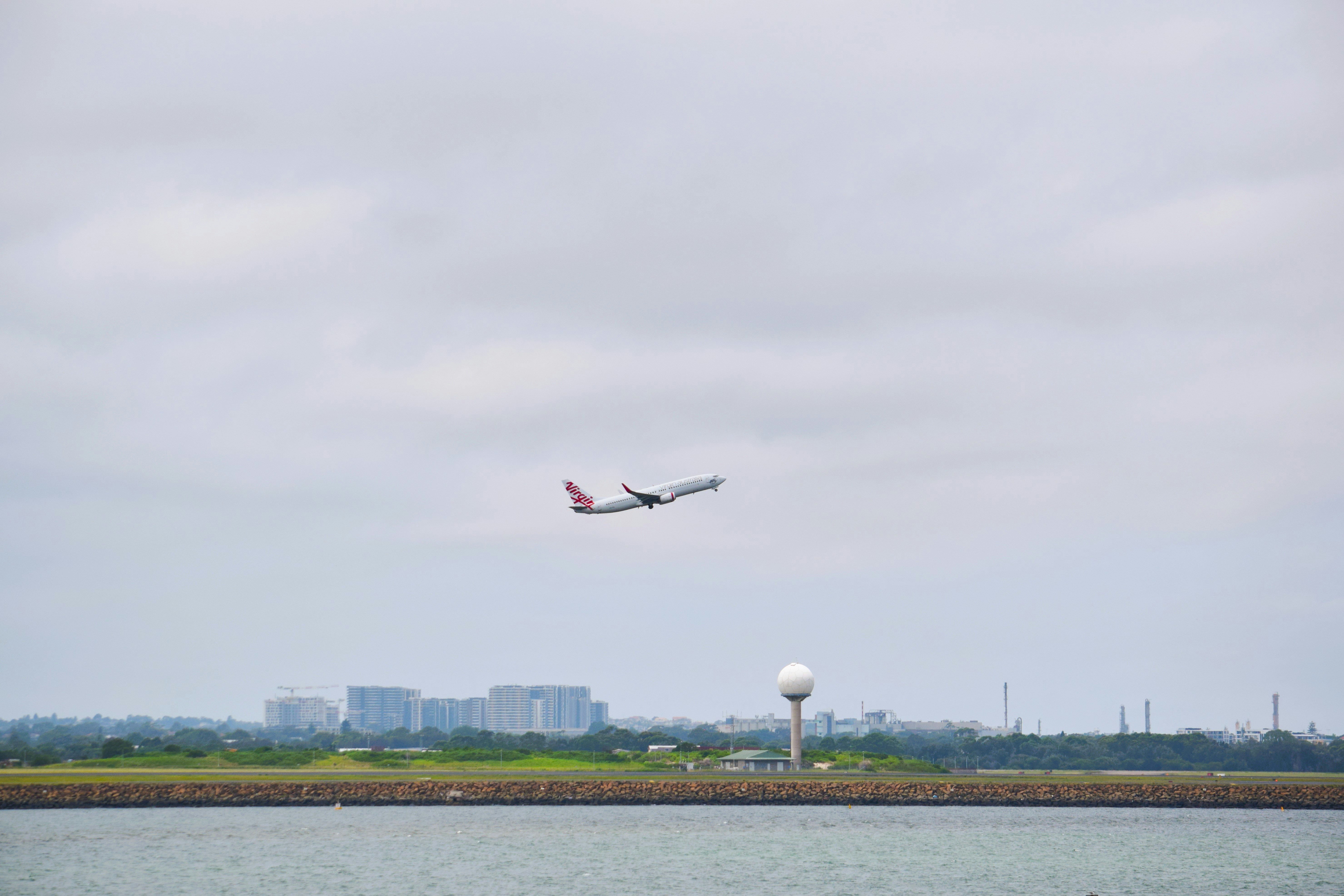 Plane Lift-off Over a Calm Coastal Horizon