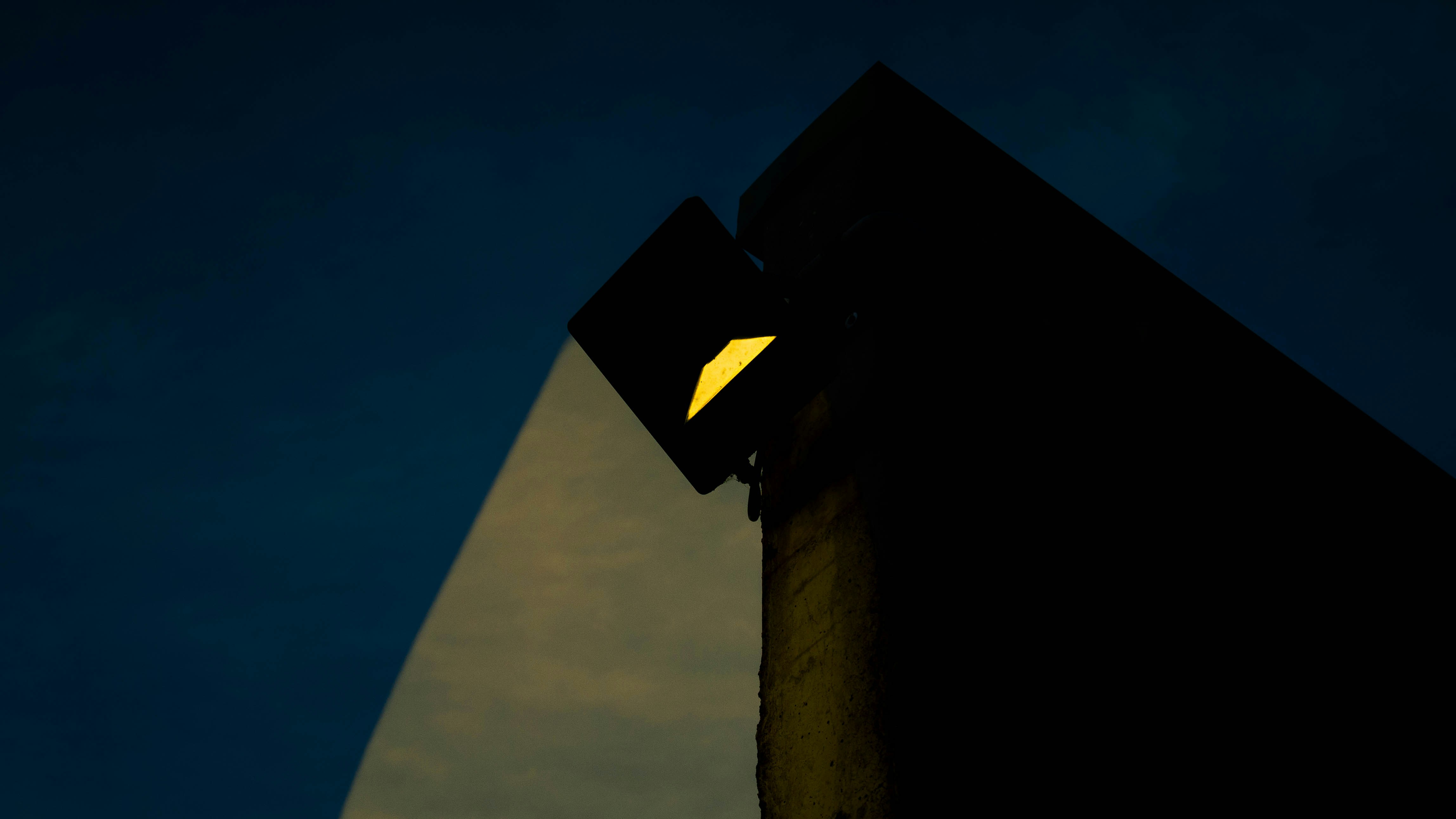 Amber Beacon on a Sharp Corner Under Indigo Night