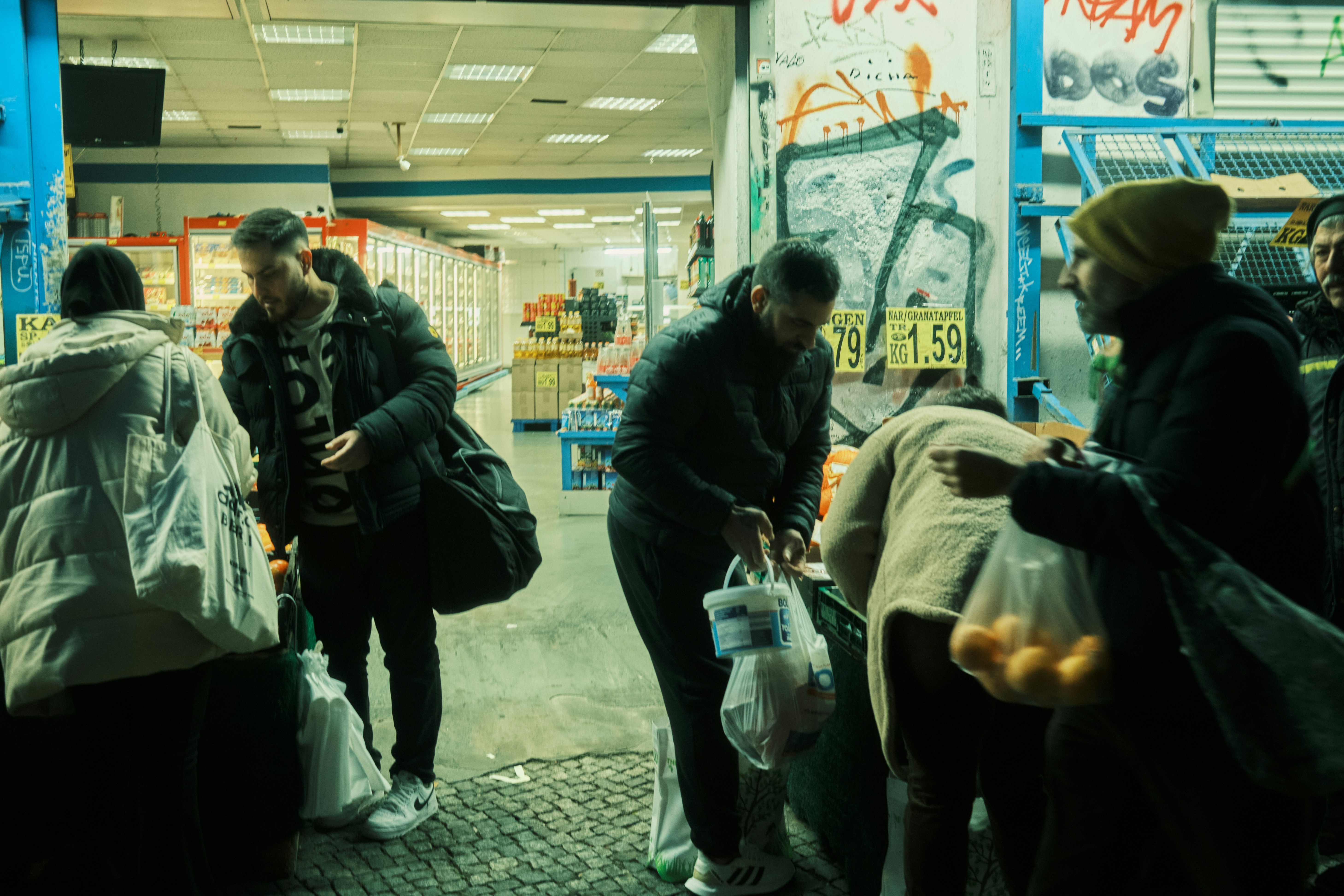 Graffiti Glare and Quiet Hurry in a Neon Market