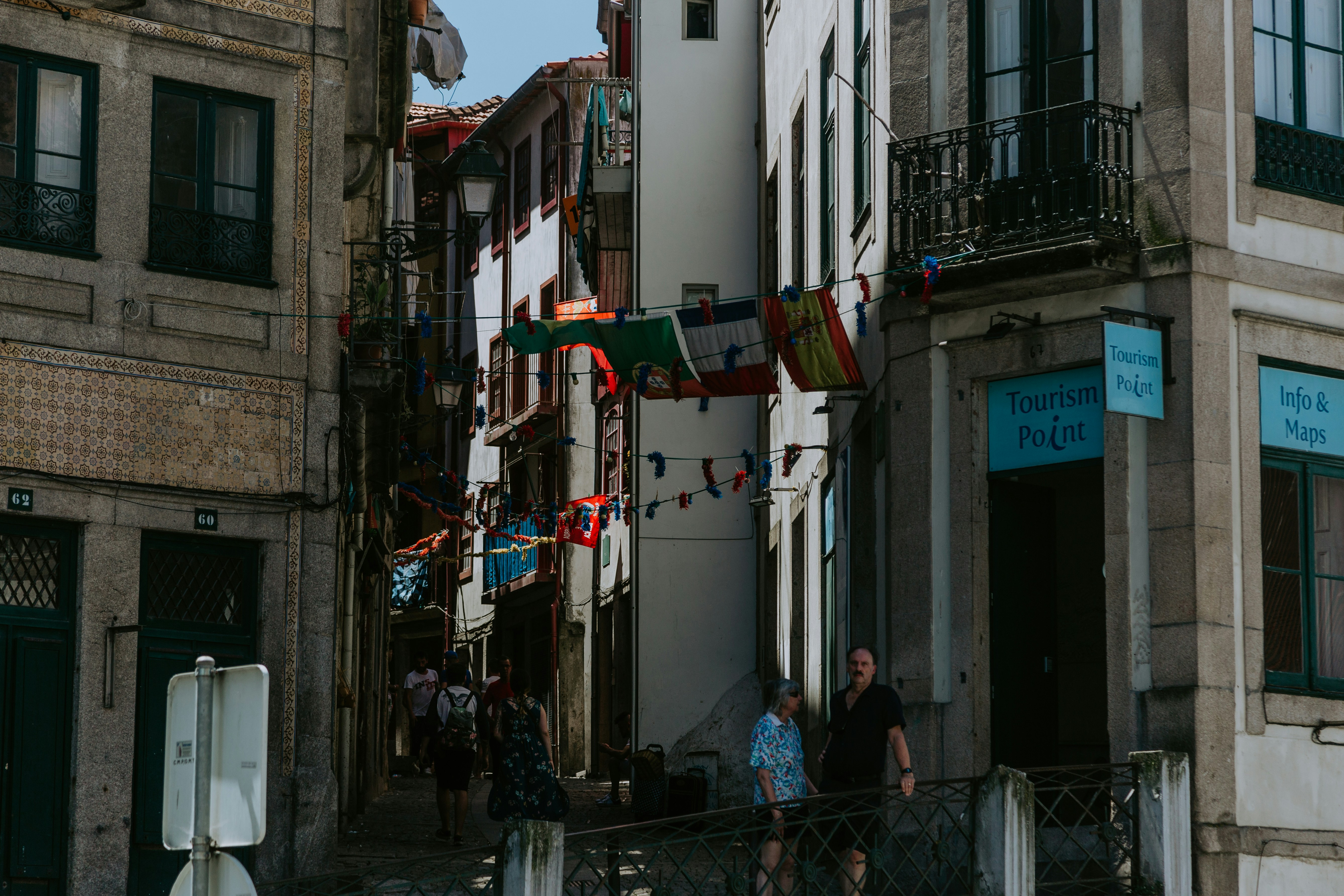 Flag-Threaded Lane: Sunlit Moments Between Stone Facades