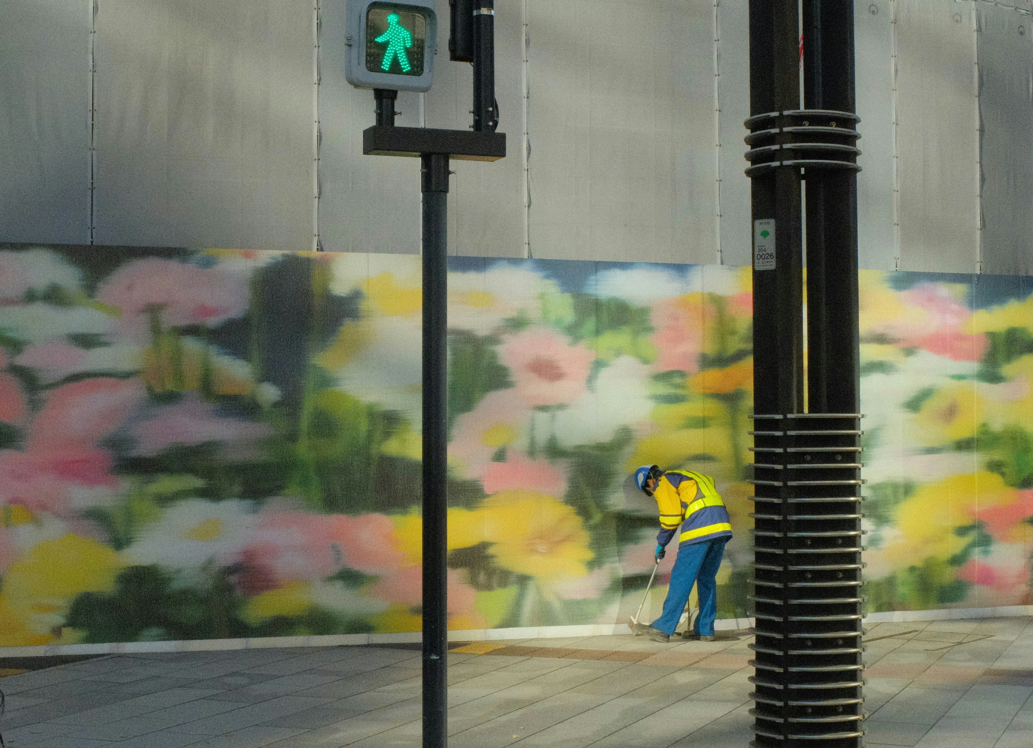 Color-Washed Streetwork: A Safety-Vested Worker Before a Vivid Muralscape