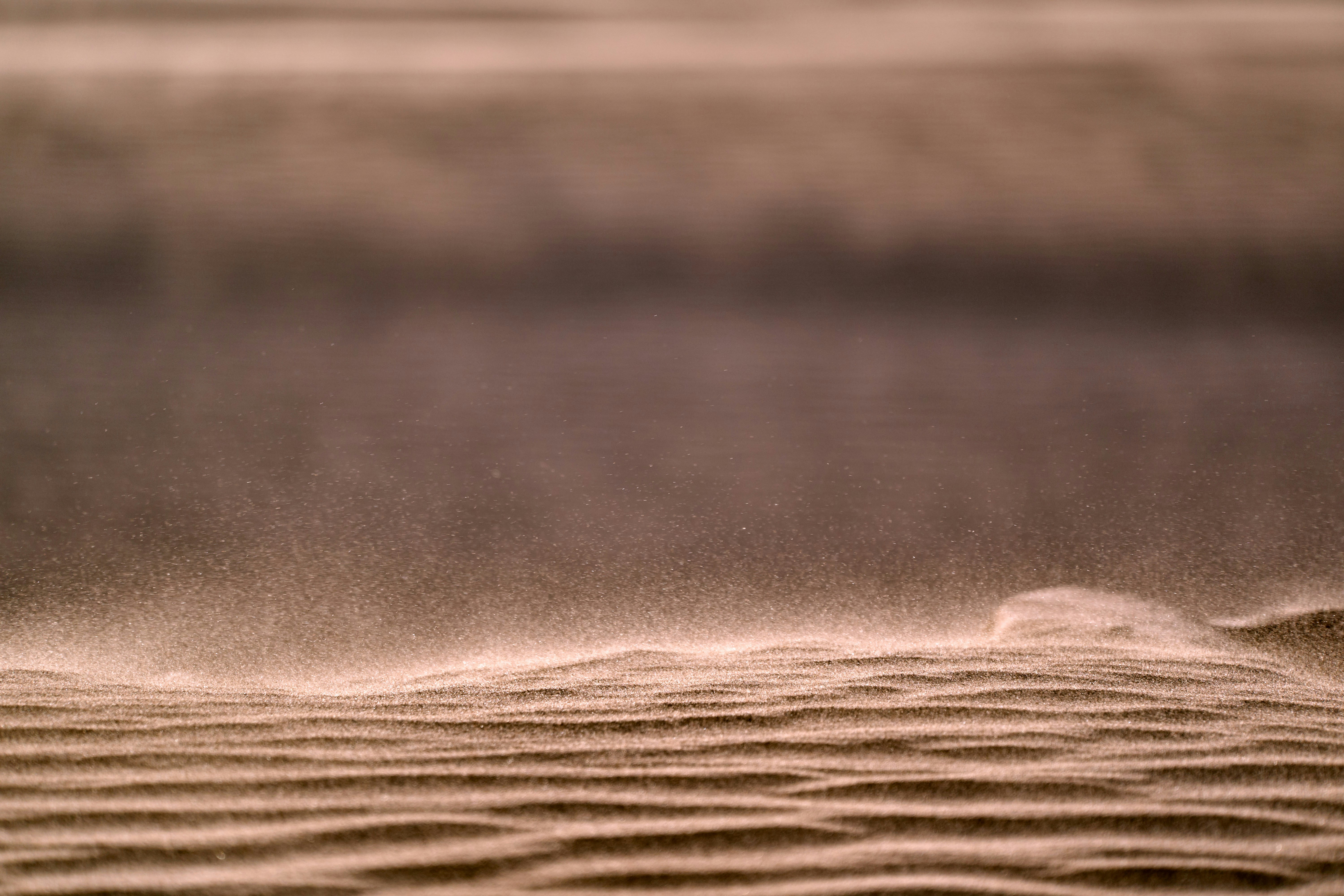 A picture of sand blowing in the wind photo – Free Grey Image on Unsplash