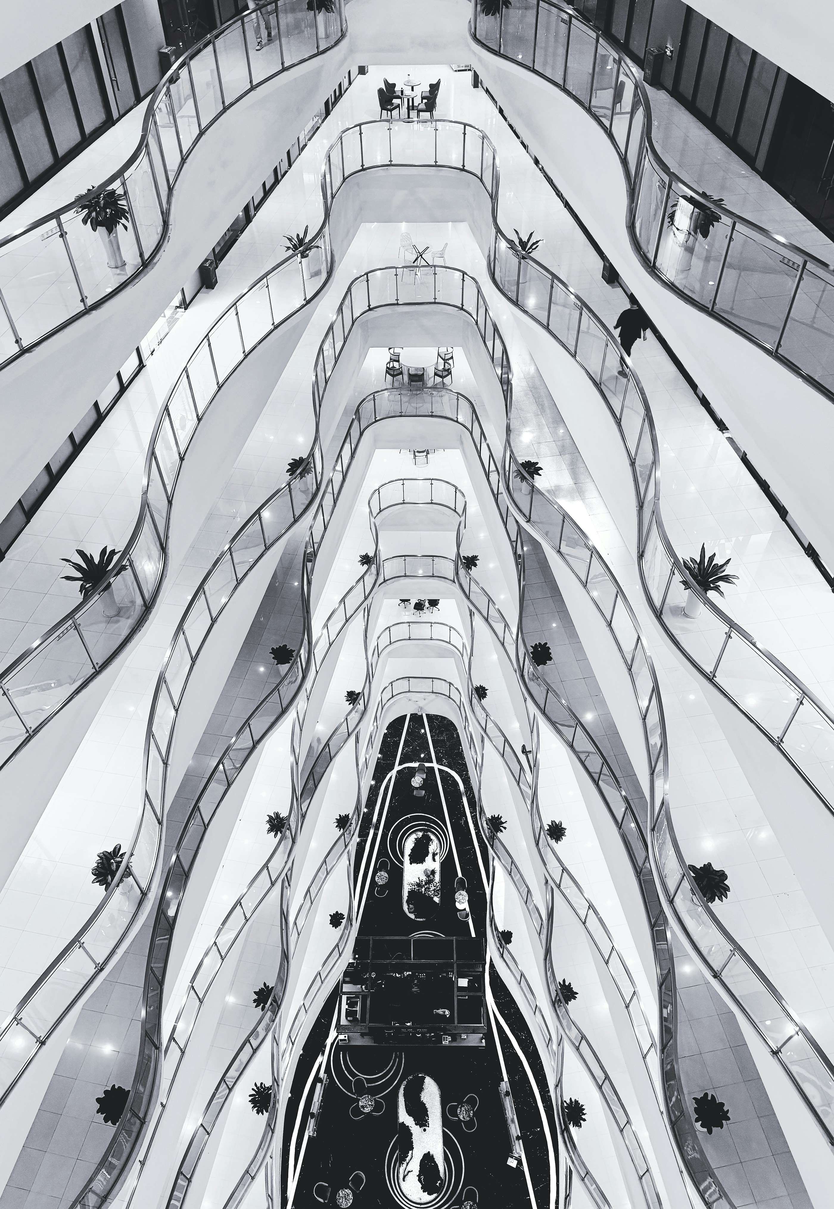 Spiral Atrium: A Monochrome Sweep of Escalators