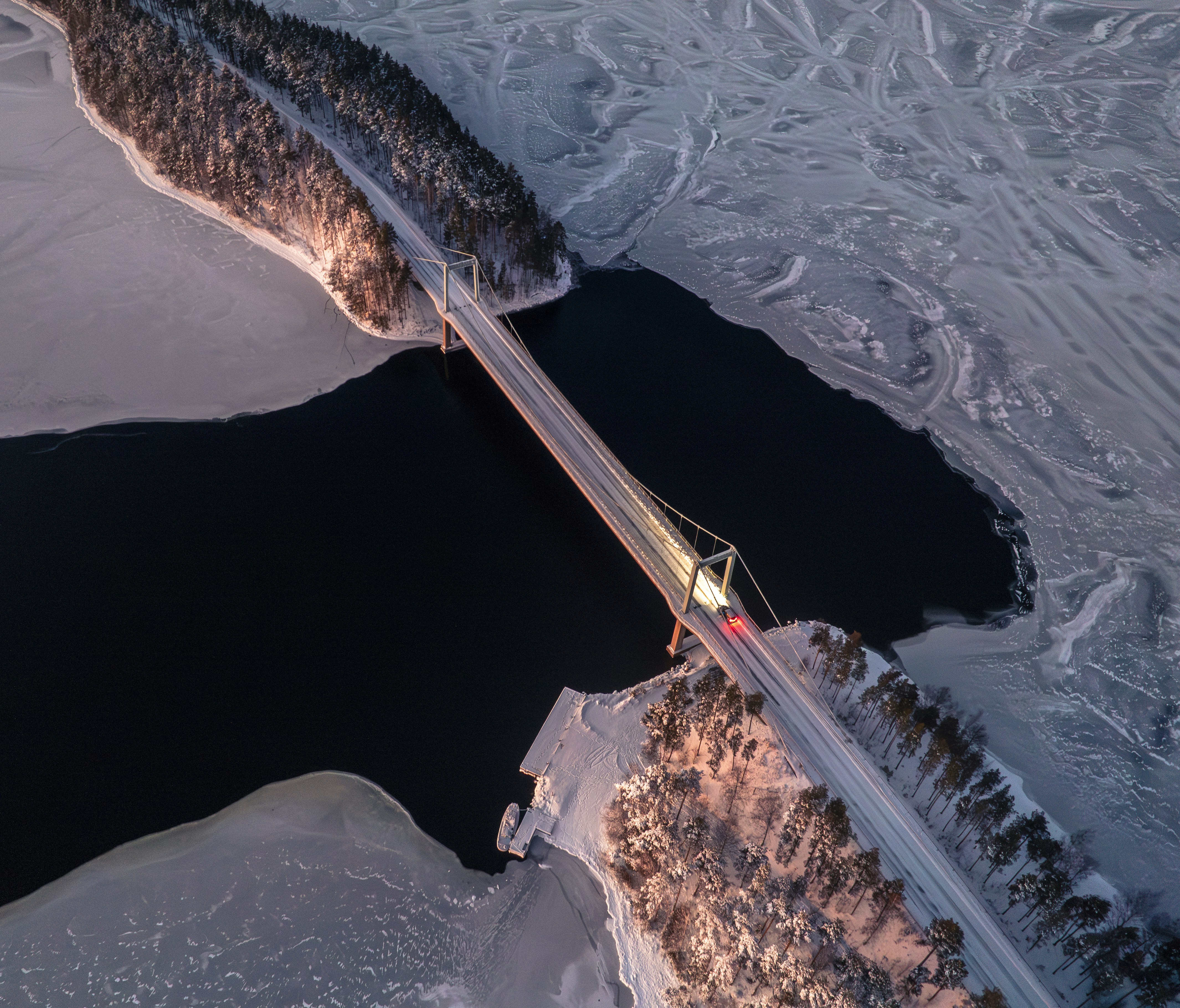 Photo taken in Finland. Car drive through lake on the bridge