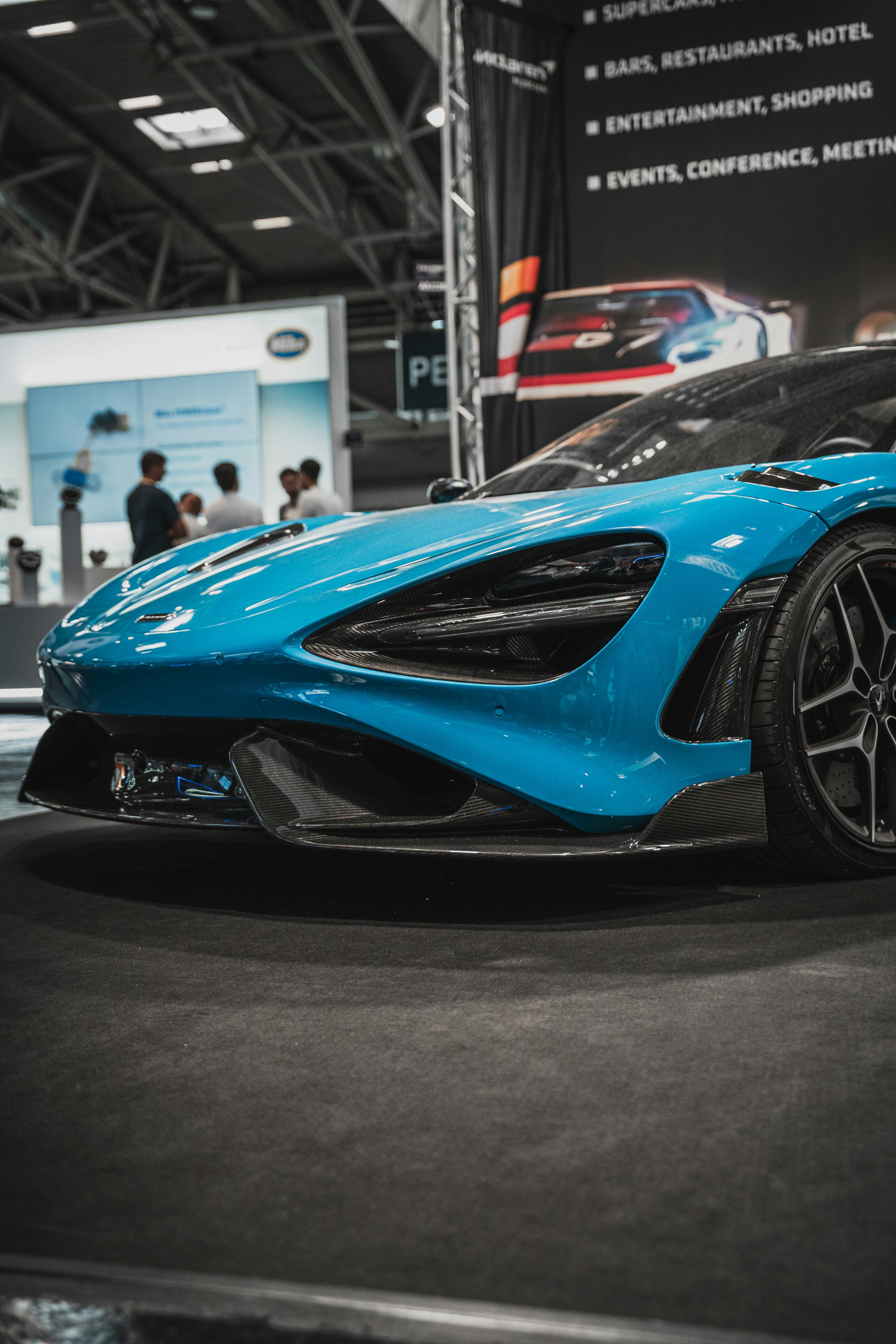 A blue sports car on display at a car show photo – Free Vehicle Image ...