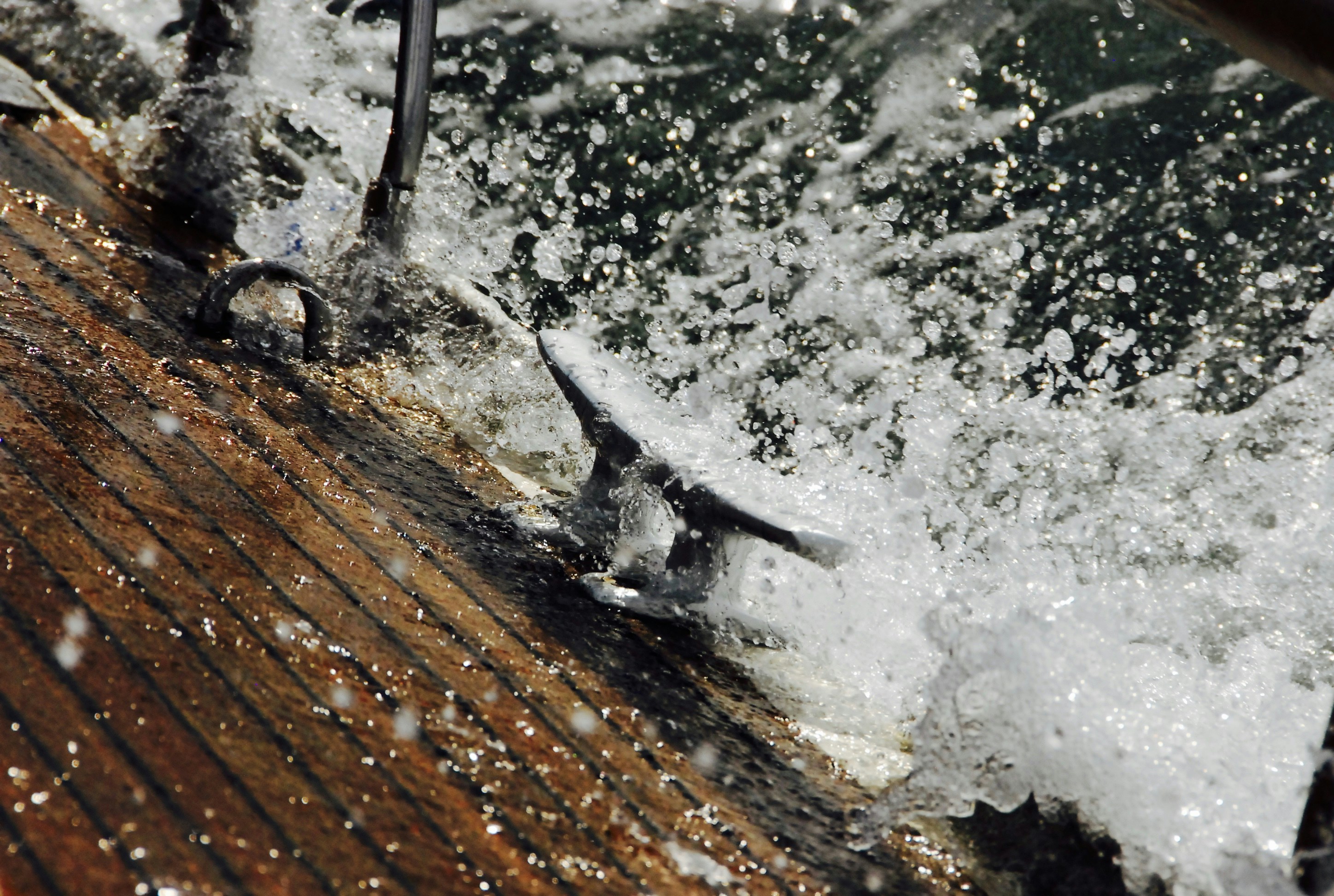Water crashing onto a wooden deck, creating an energetic splash.