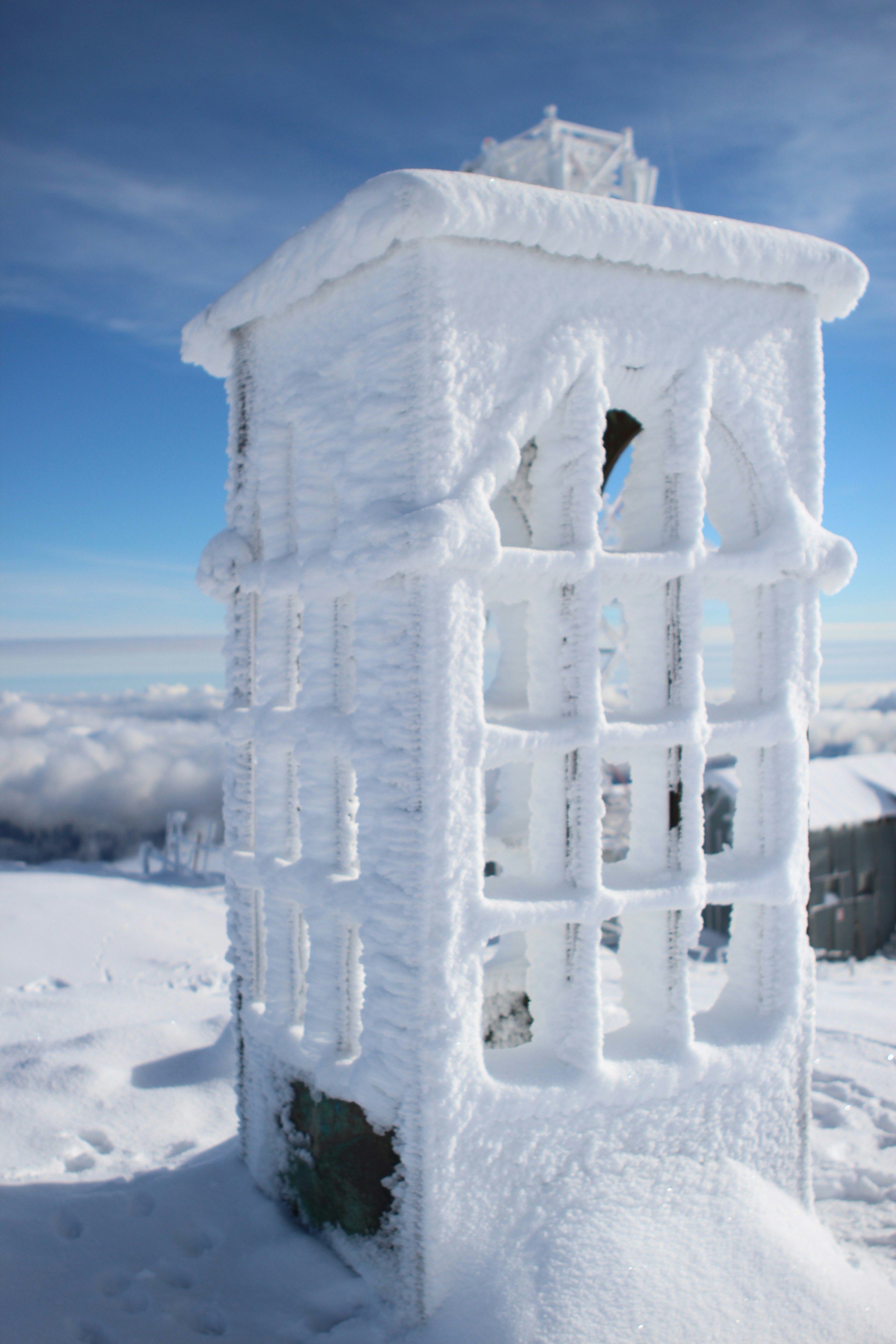 Frostbound Lattice Tower Under a Clear Blue Sky