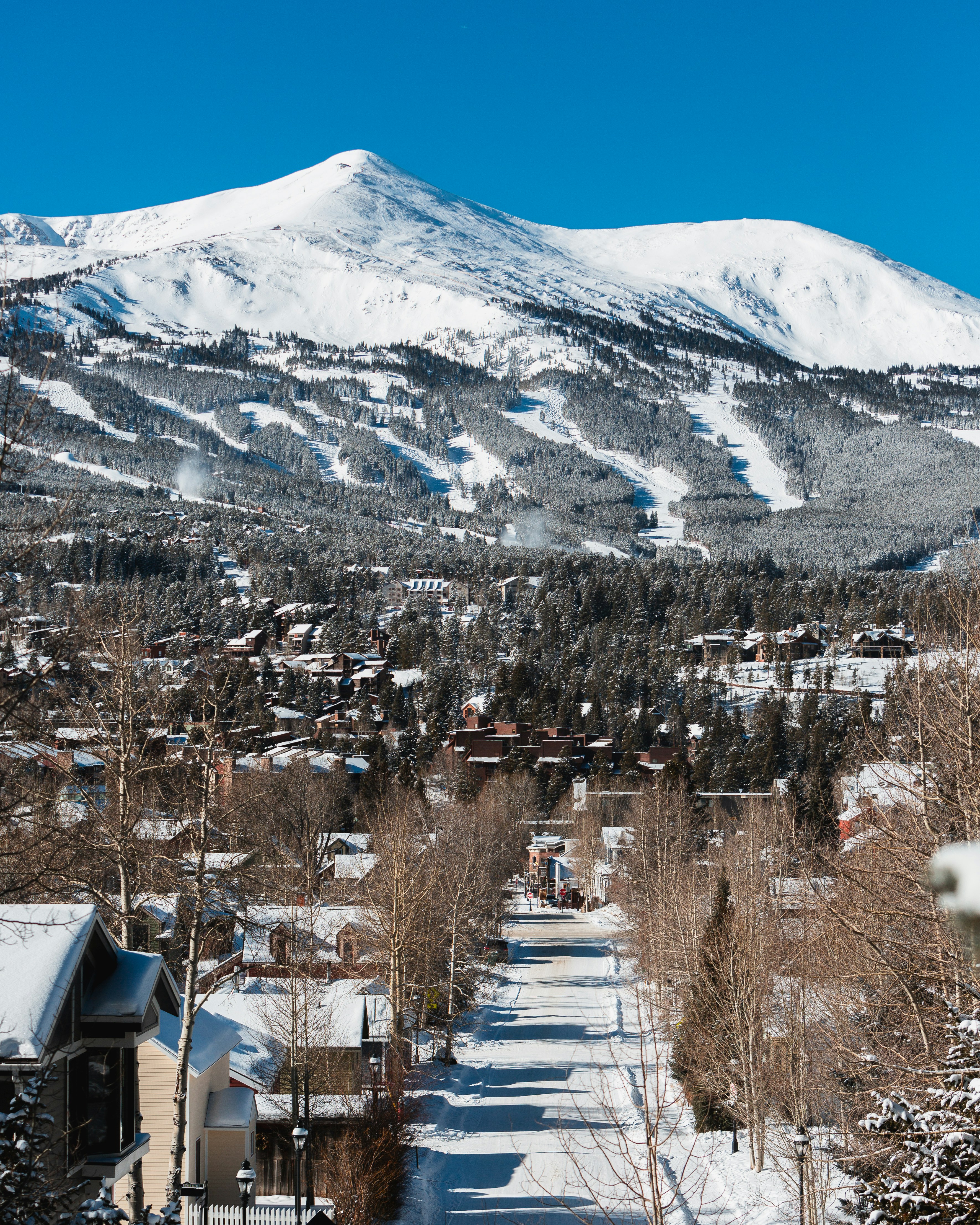 A view of a town with a mountain in the background photo – Free ...