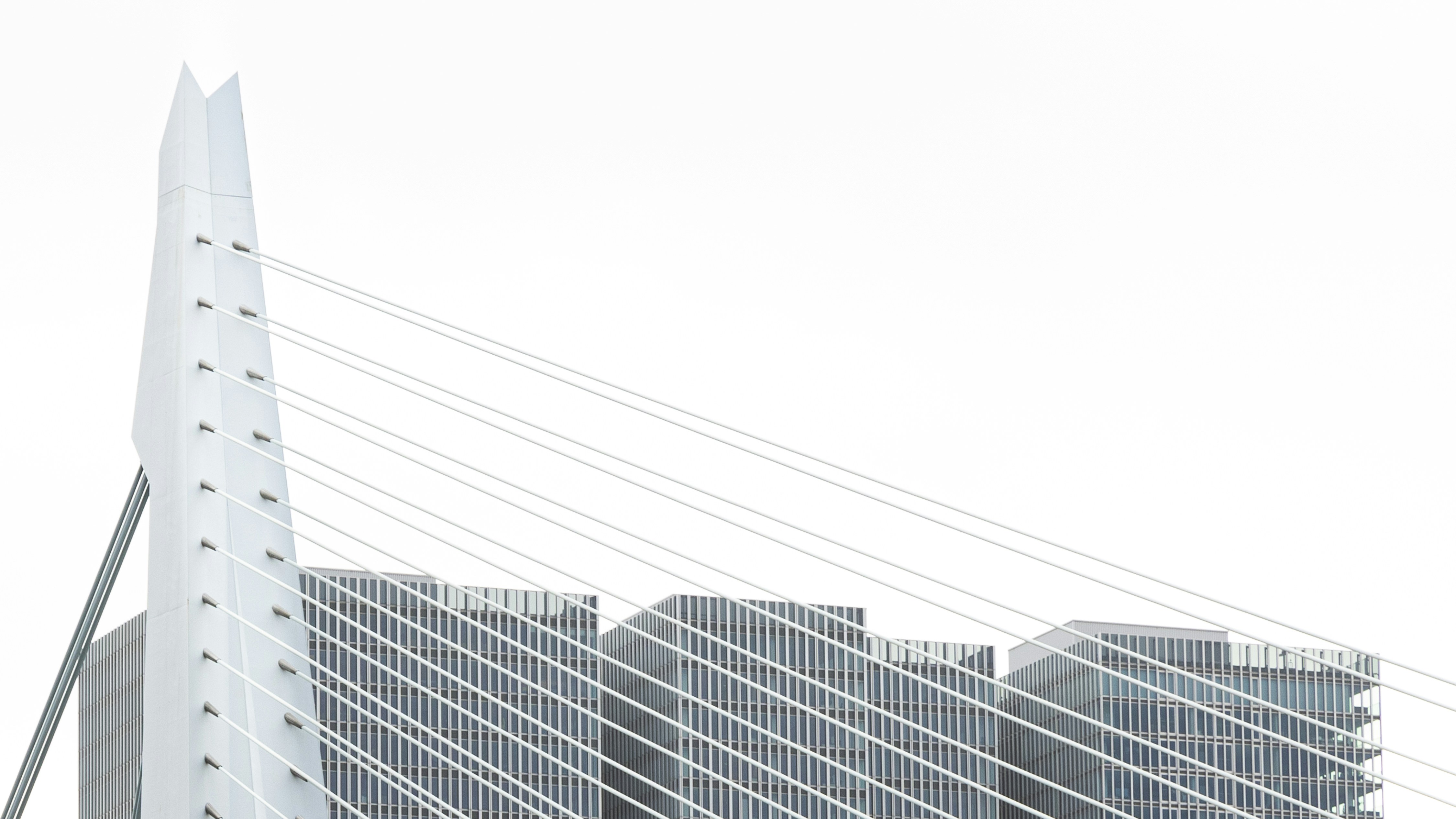 A very tall white building with a very long bridge photo – Free ...