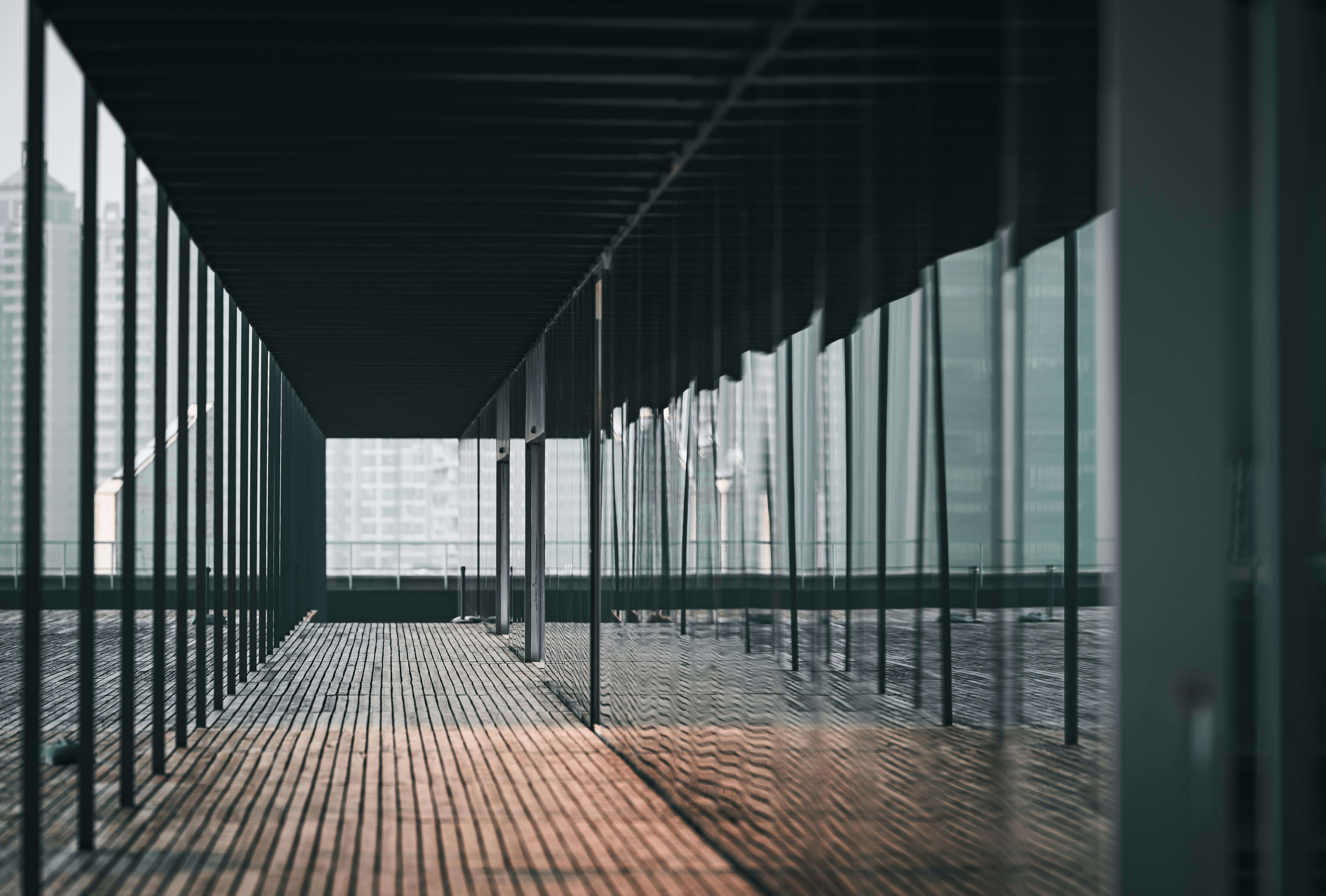 A long hallway with metal bars on the sides of it photo – Free Business ...