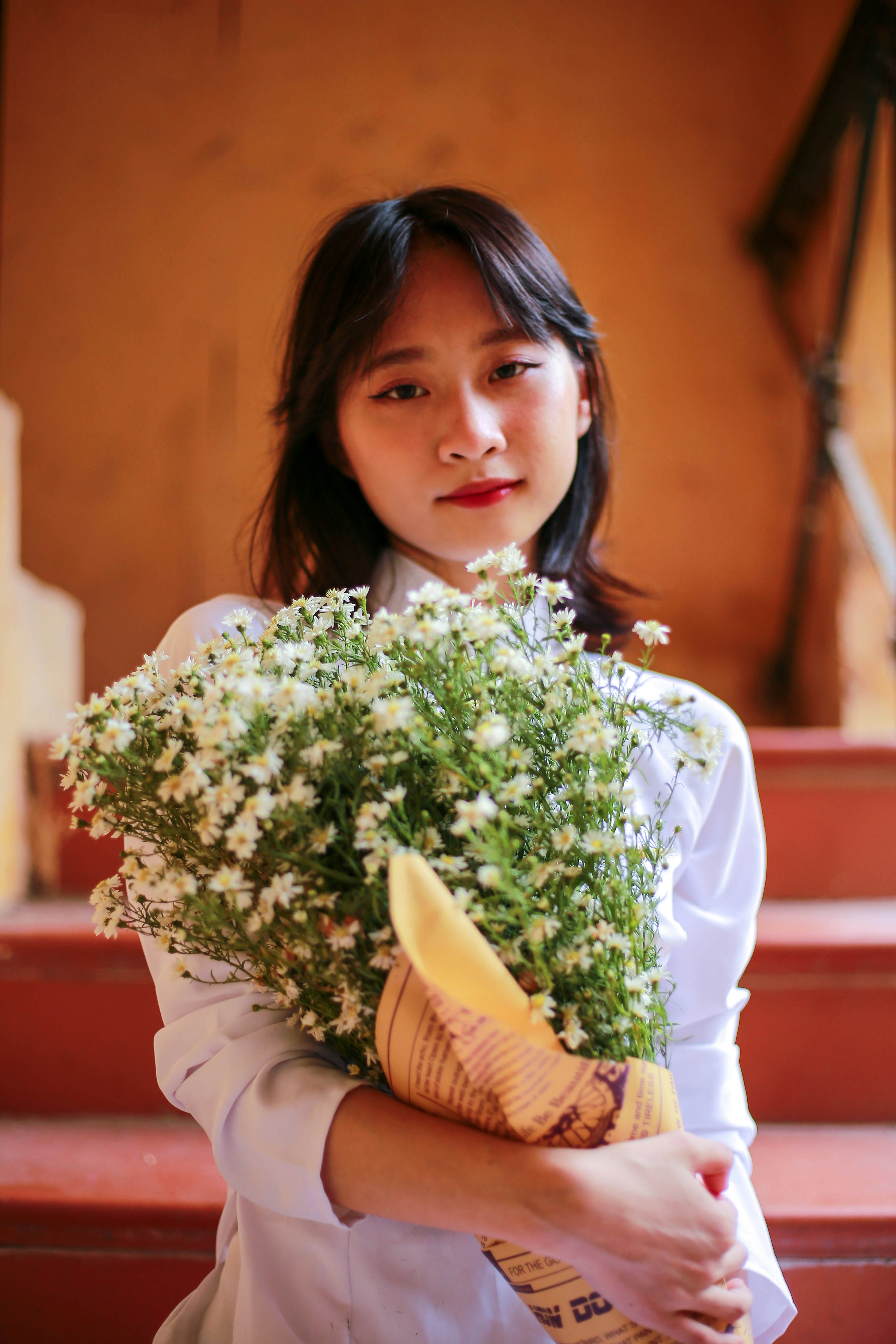 Amber Staircase Portrait: A Quiet Smile with White Wildflowers