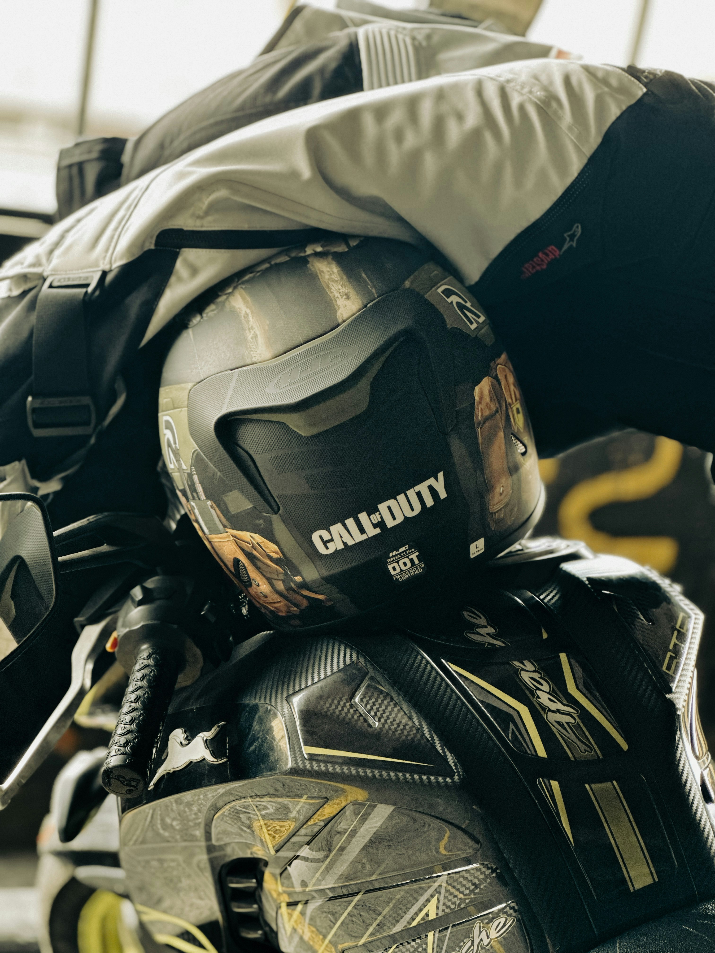 Duty on Display: A Tactical Helmet Resting Above Carbon-Fiber Racing Gear