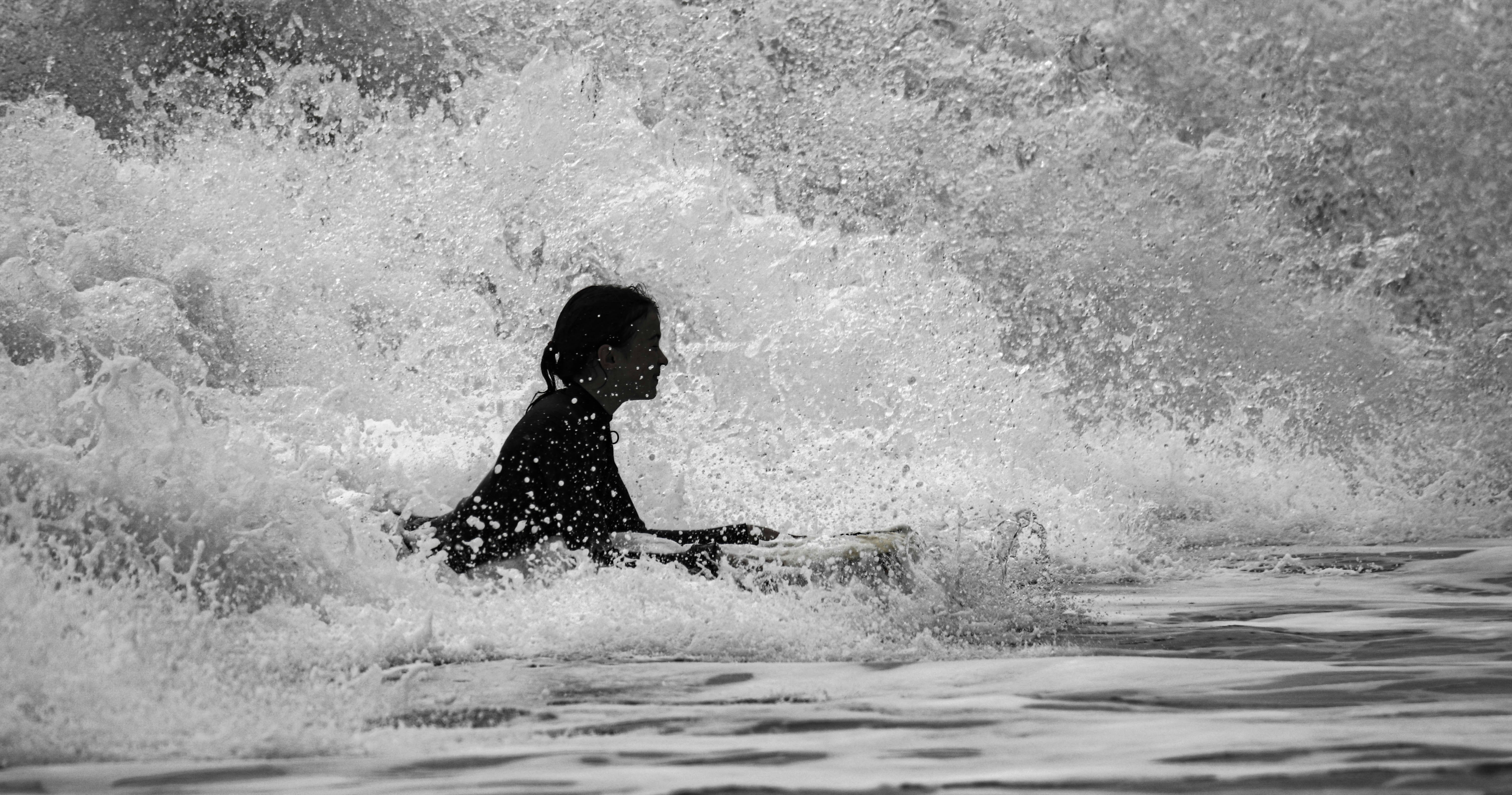 A person riding a surfboard on a wave in the ocean photo – Free Waves ...