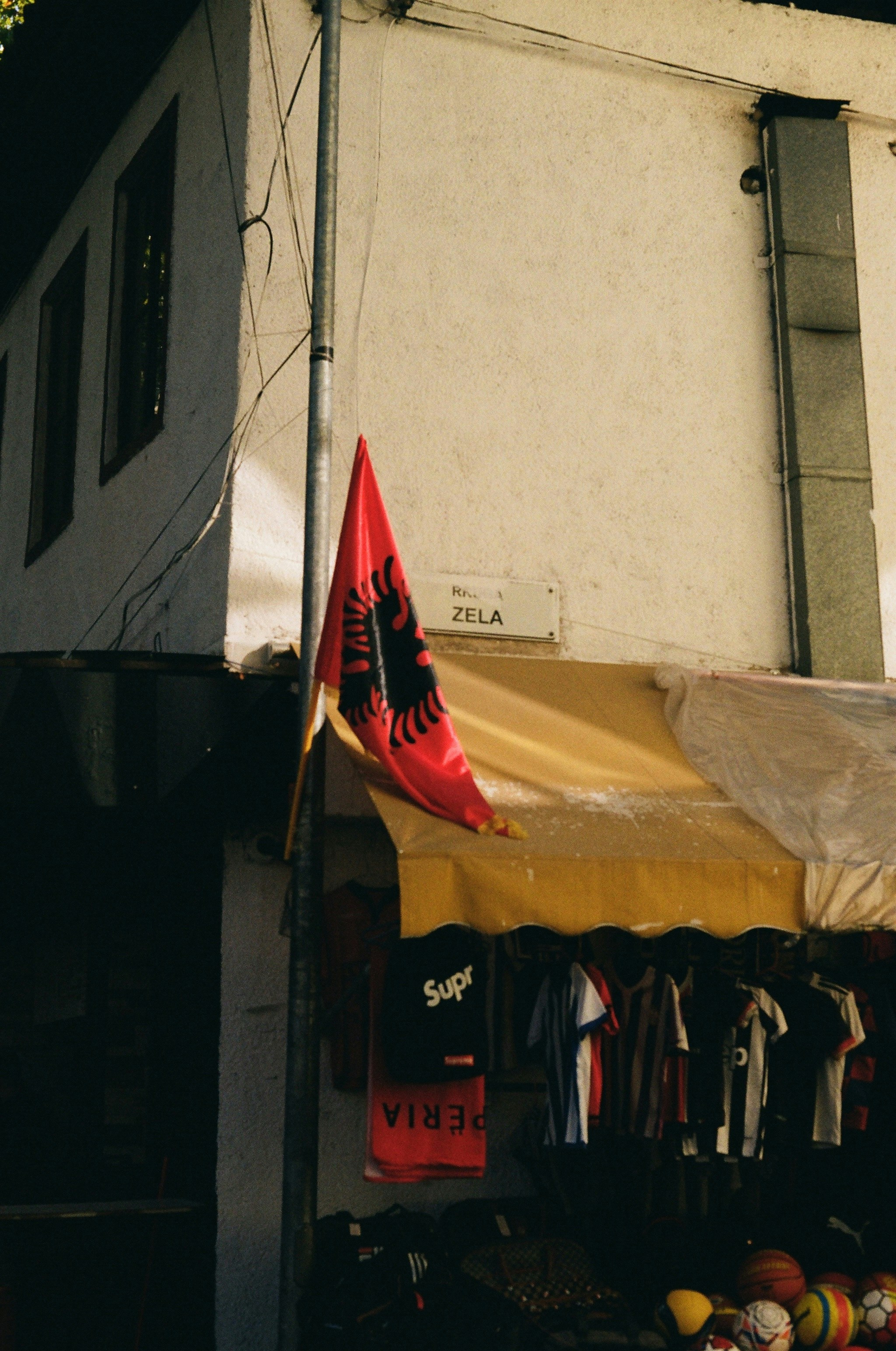 The Albanian flag on a market street in Tirana.