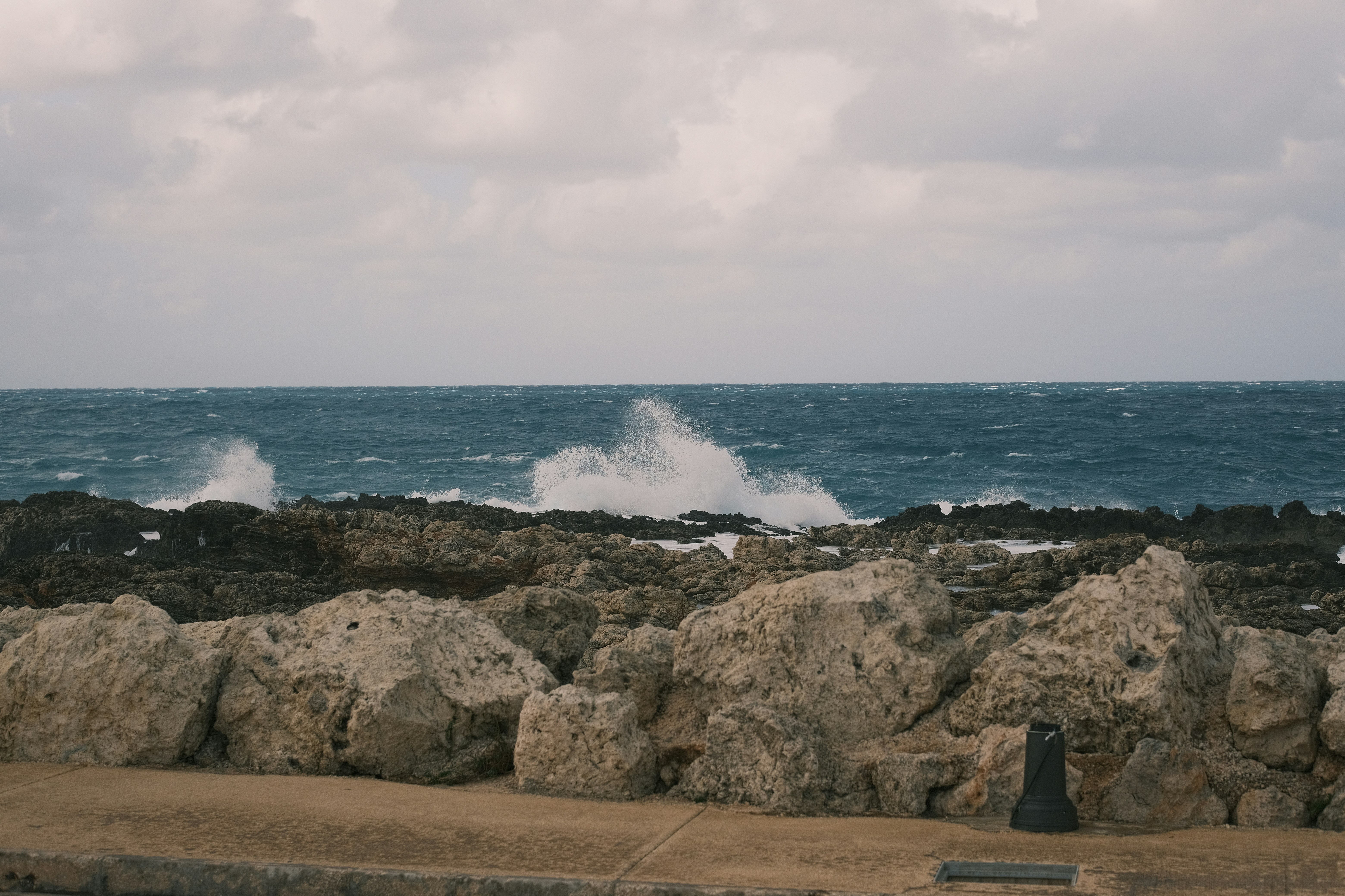 Foam Above Granite: Waves Clash on a Sea-Worn Breakwater