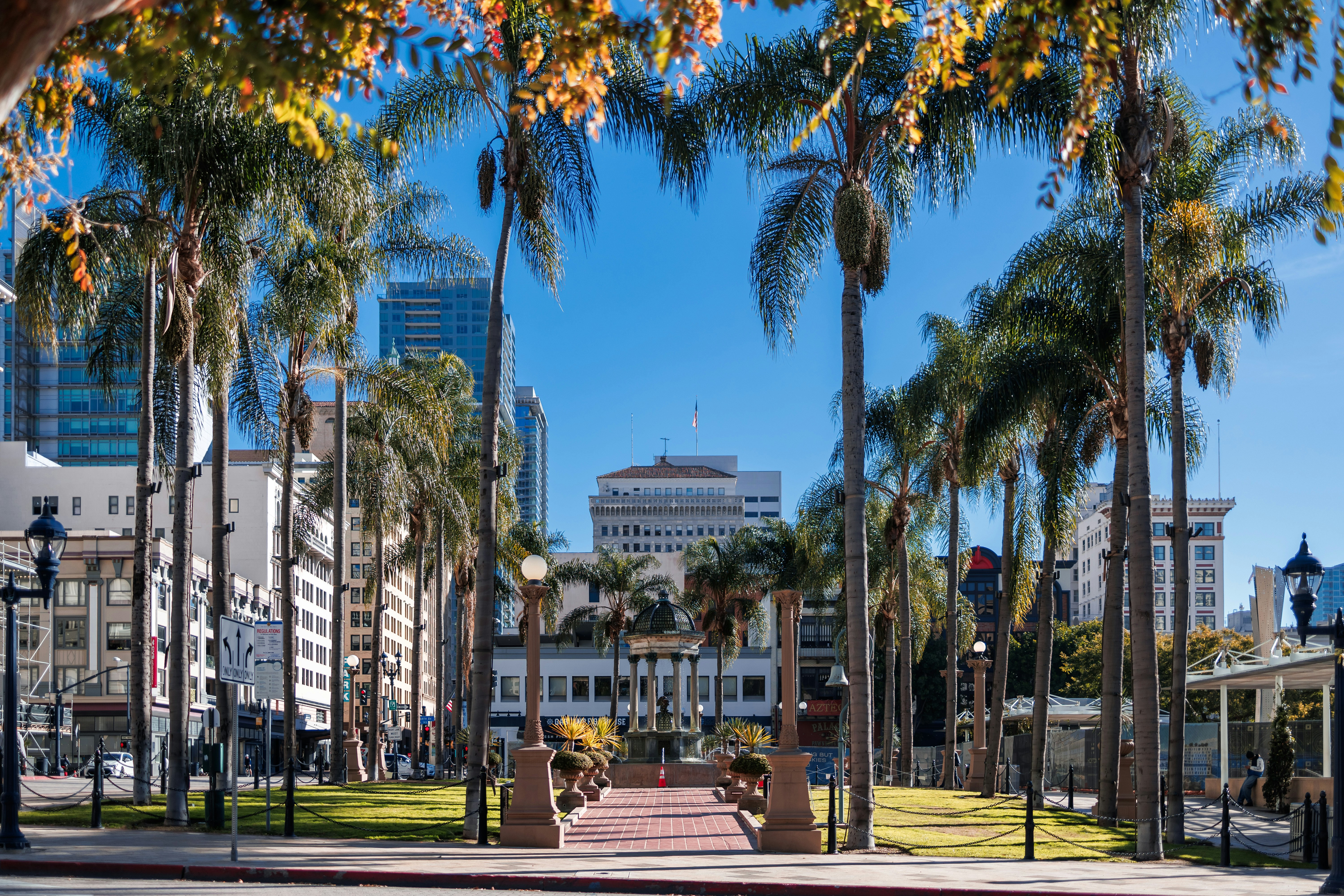 San Diego / Horton Plaza | a city street with palm trees and buildings in the background