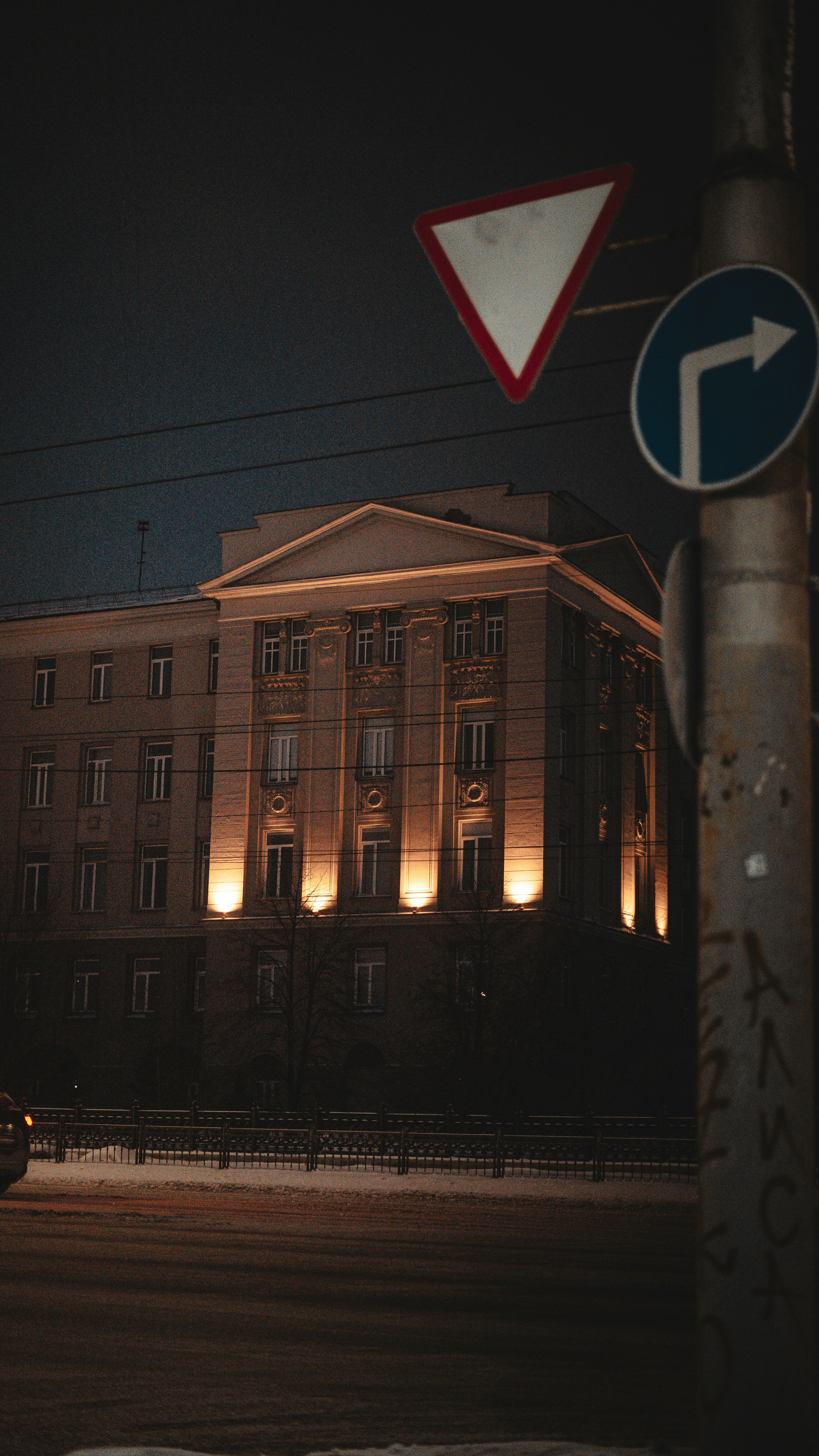 Amber-Glow Facade: Night Architecture Framed by Urban Signage