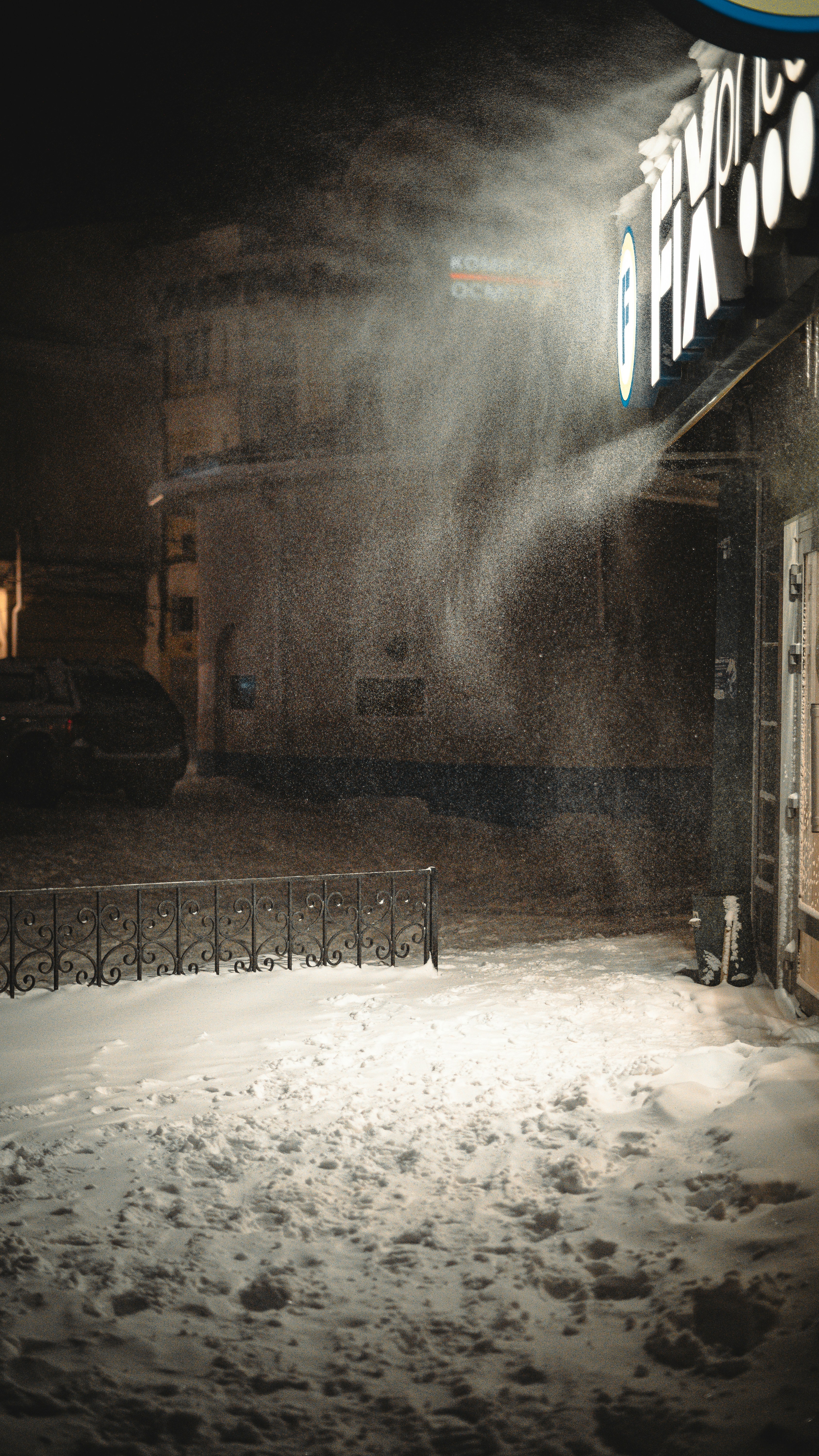 A snow blower is spraying snow on the ground photo – Free Omsk Image on ...