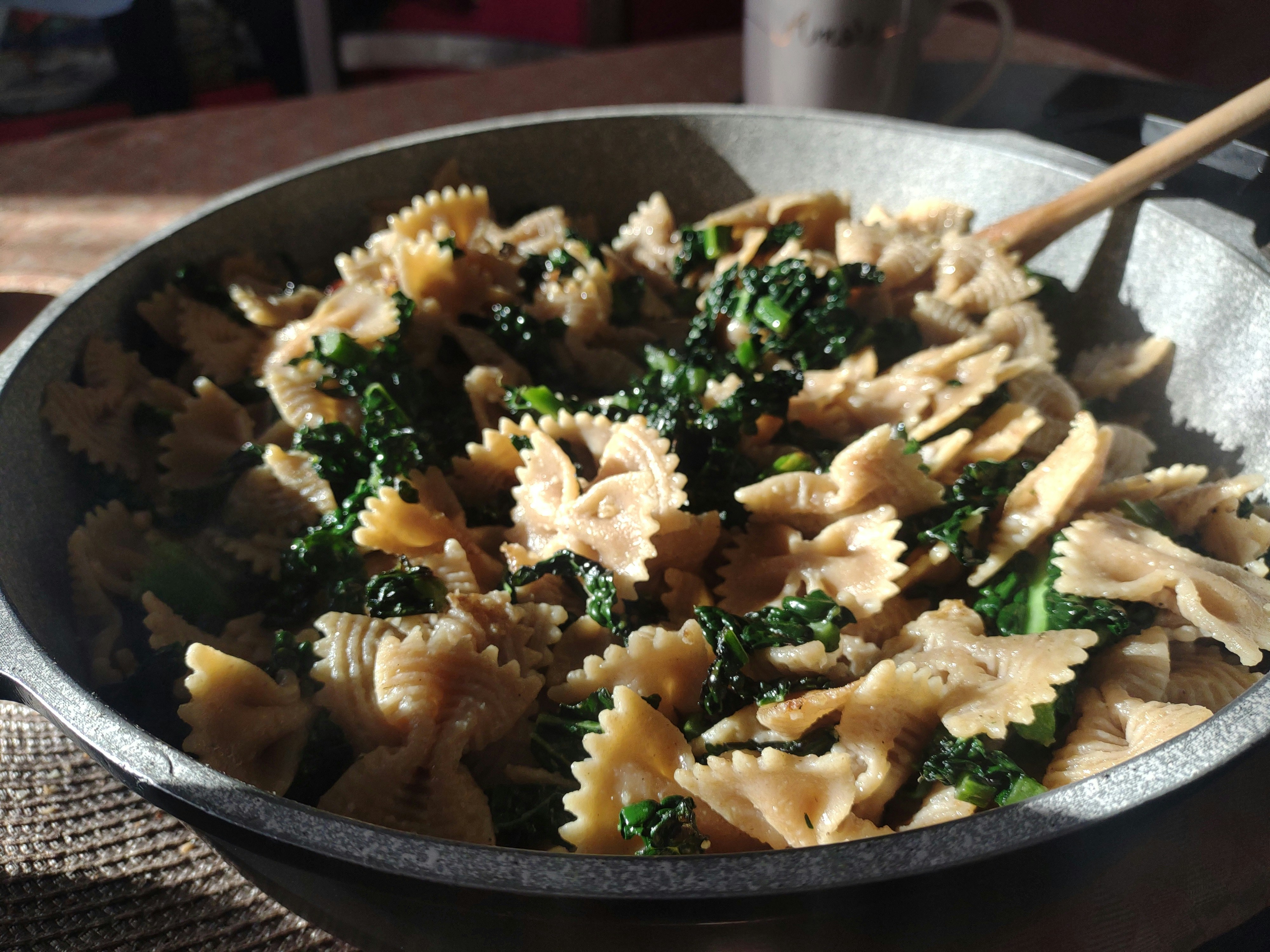A pan filled with pasta and spinach covered in sauce photo – Free Food ...