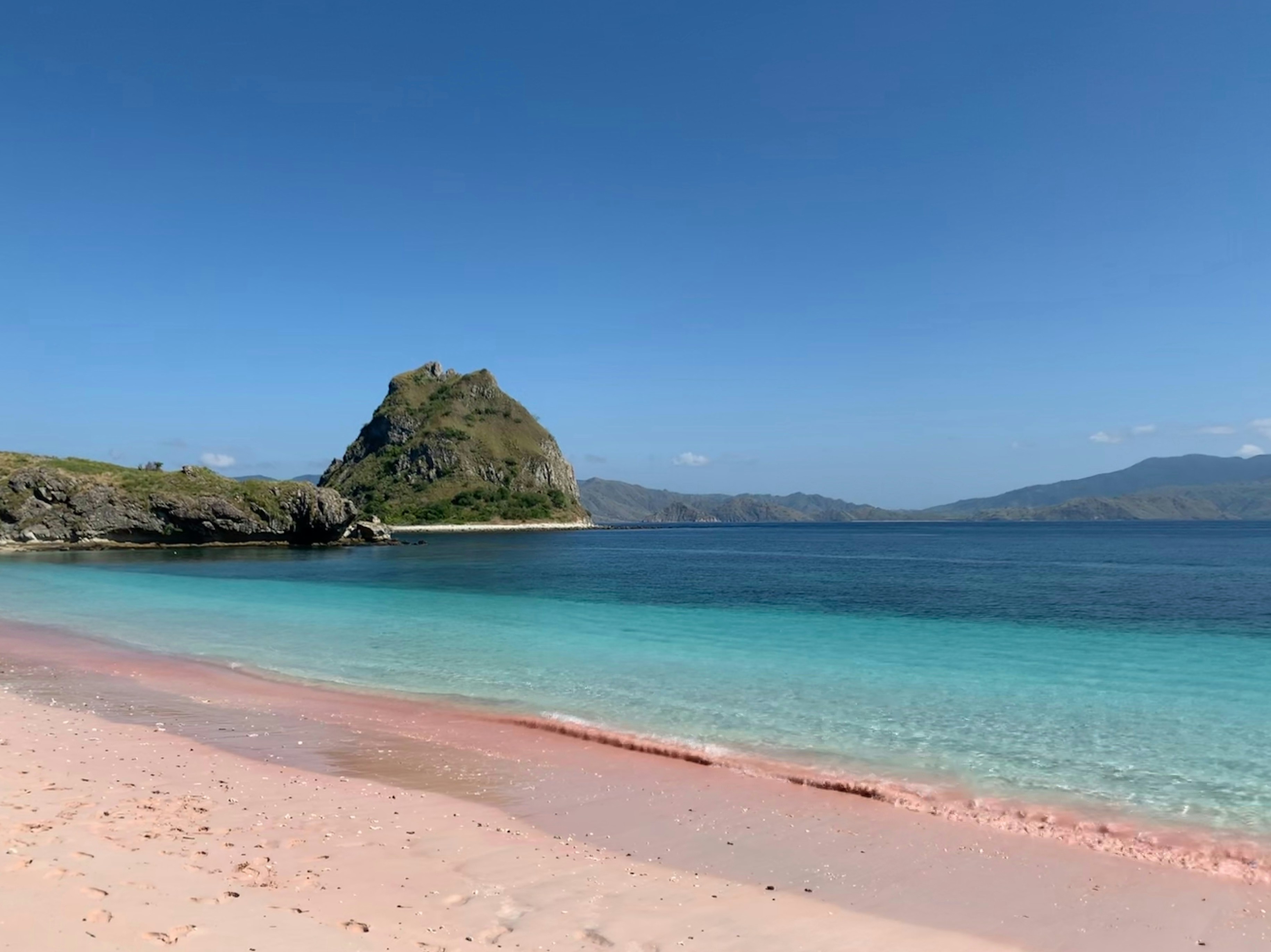 Lone Islet Against Rosy Shorelines: A Turquoise Serenade
