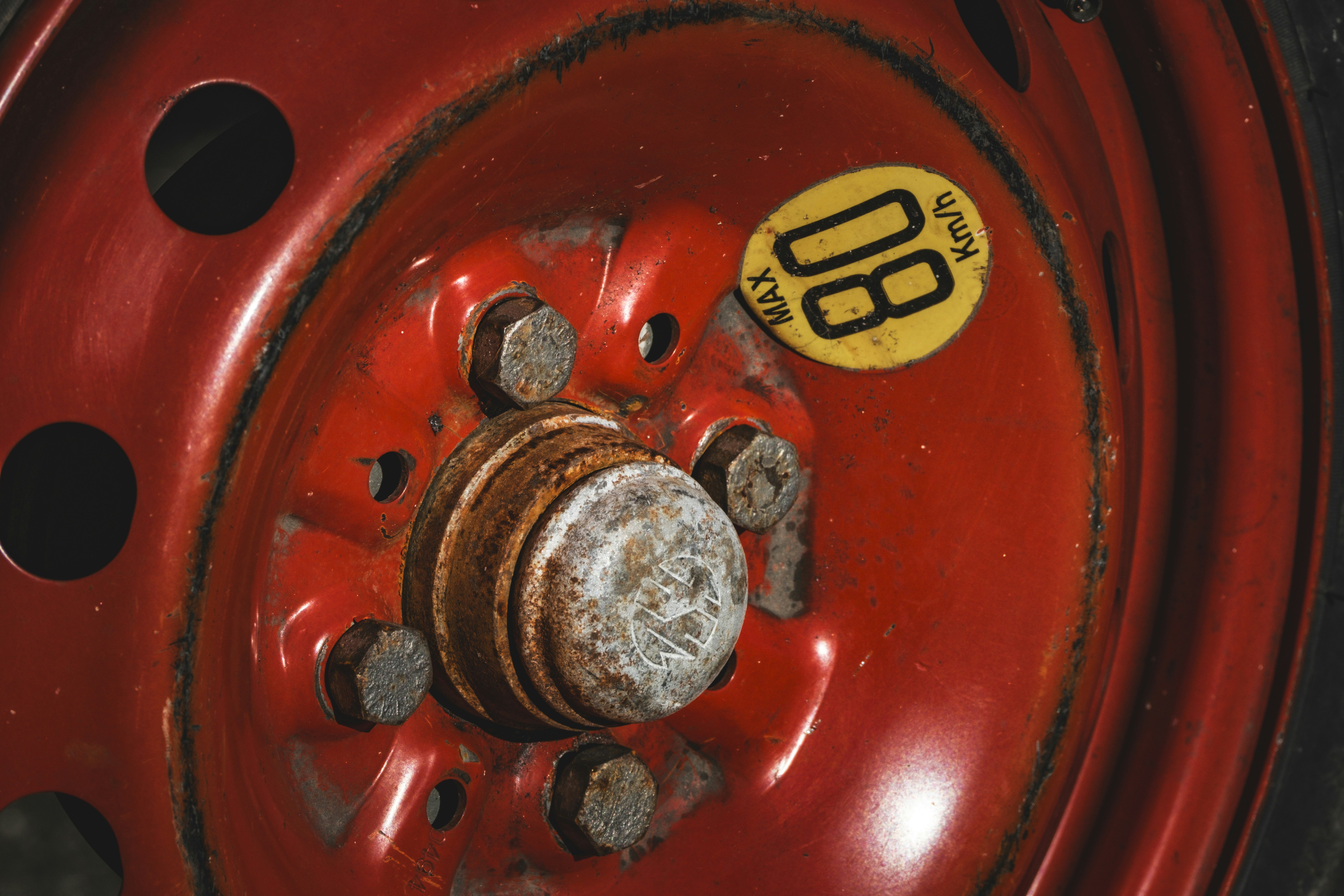 Crimson hub: a close-up study of a weathered wheel
