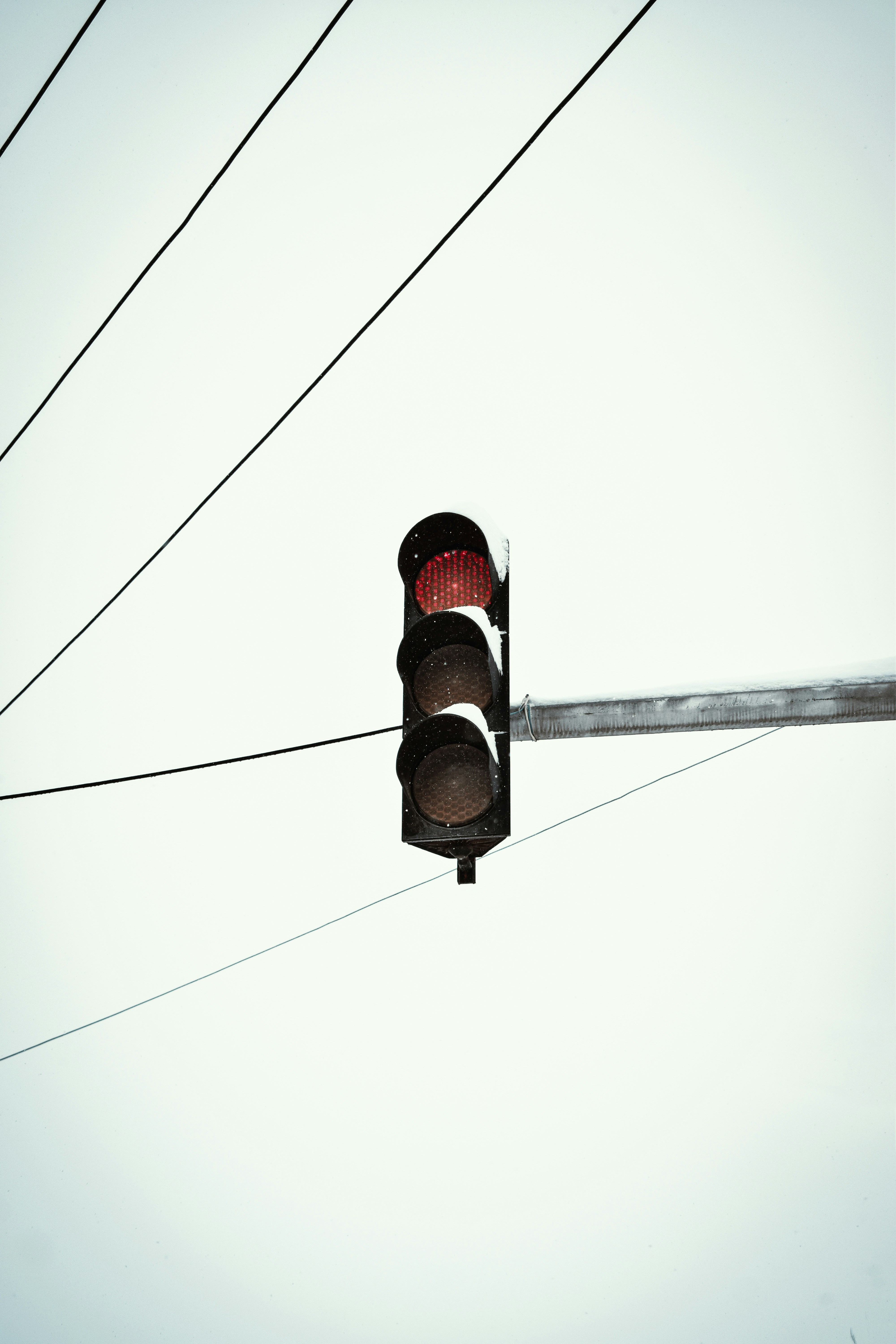 Crimson Signal Framed by Crossing Wires