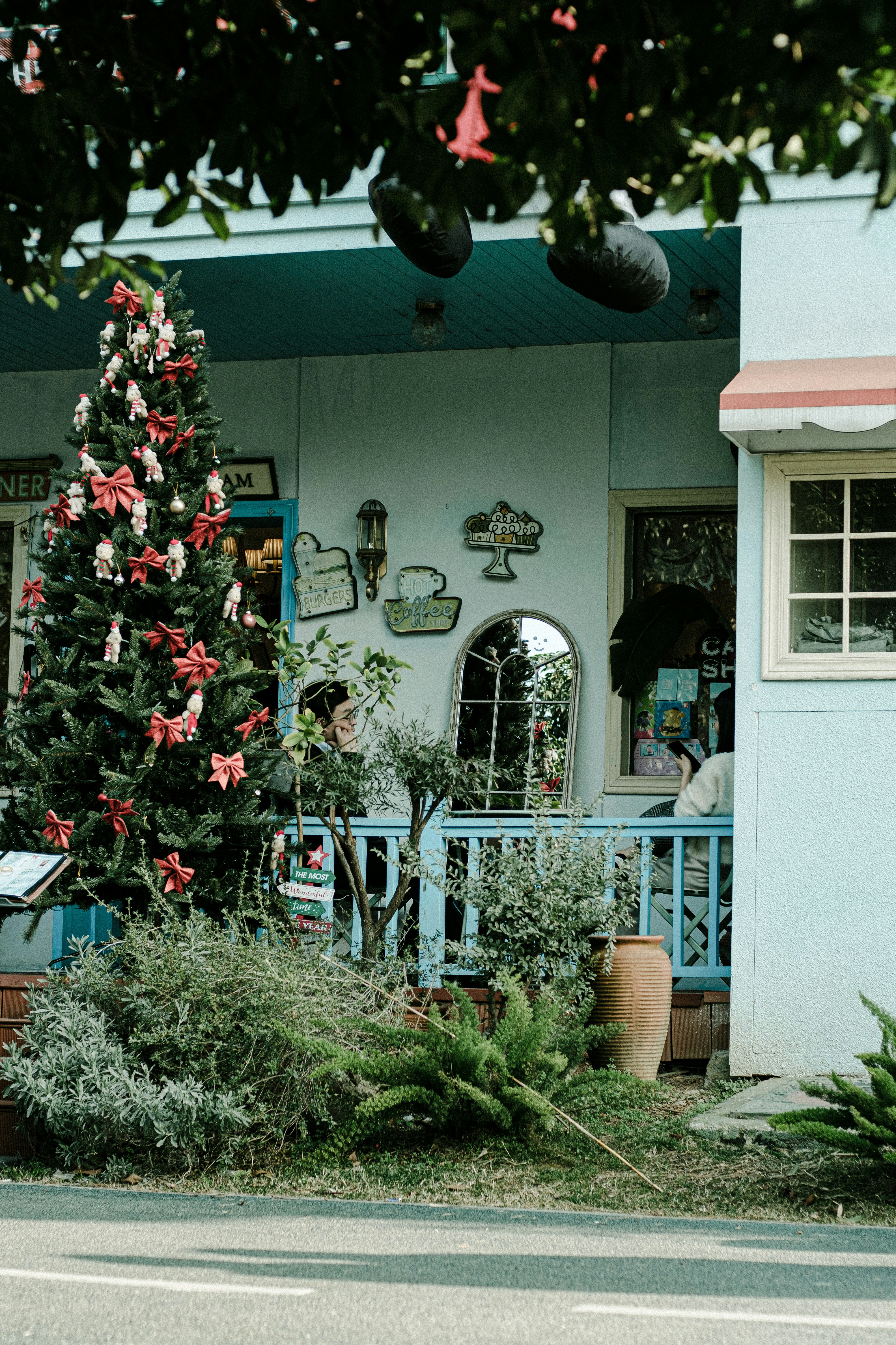 Winter Boutique Facade: A Cozy Blue Cottage with Holiday Accents