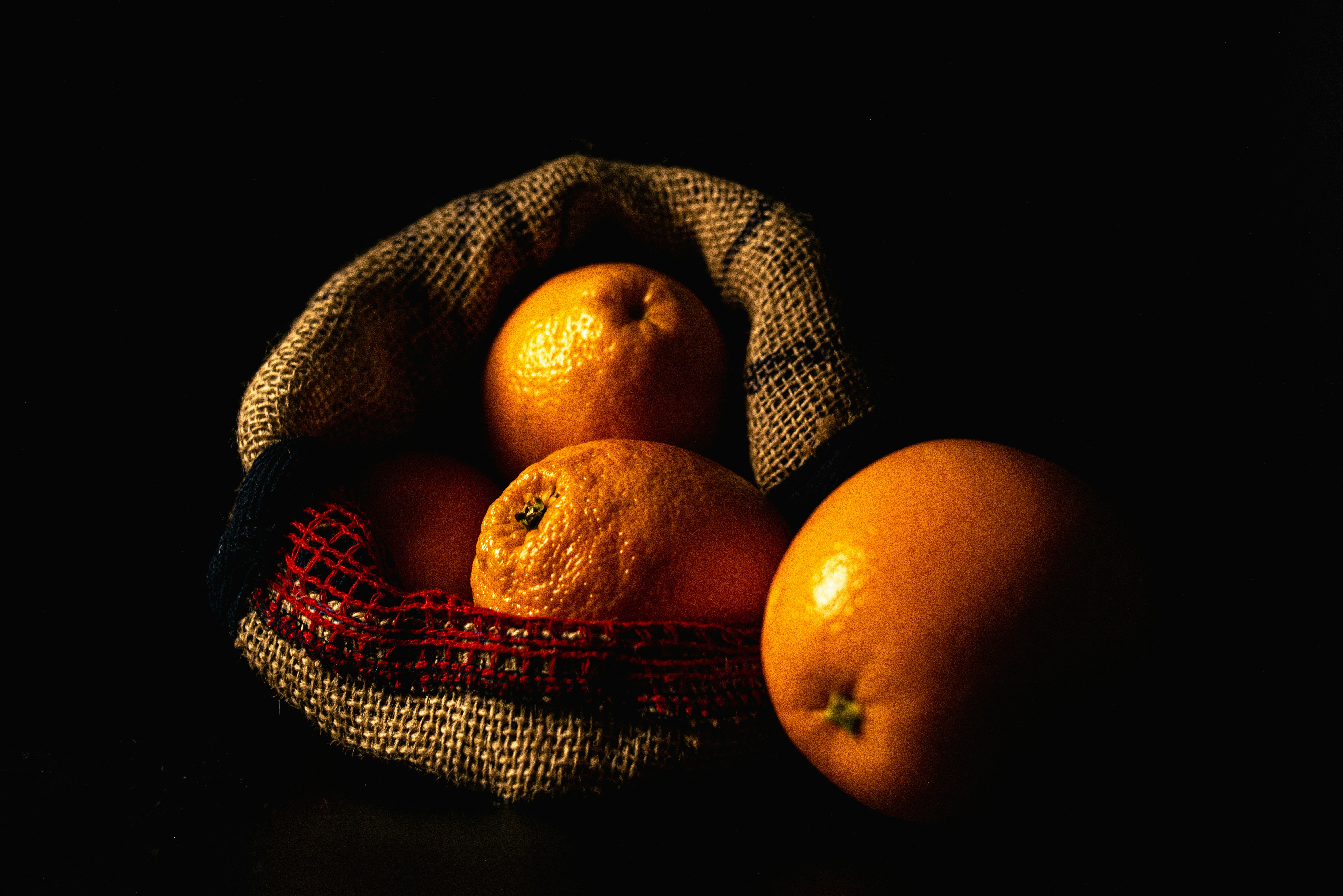 Amber Oranges in Velvet Darkness: A Burlap Still-Life