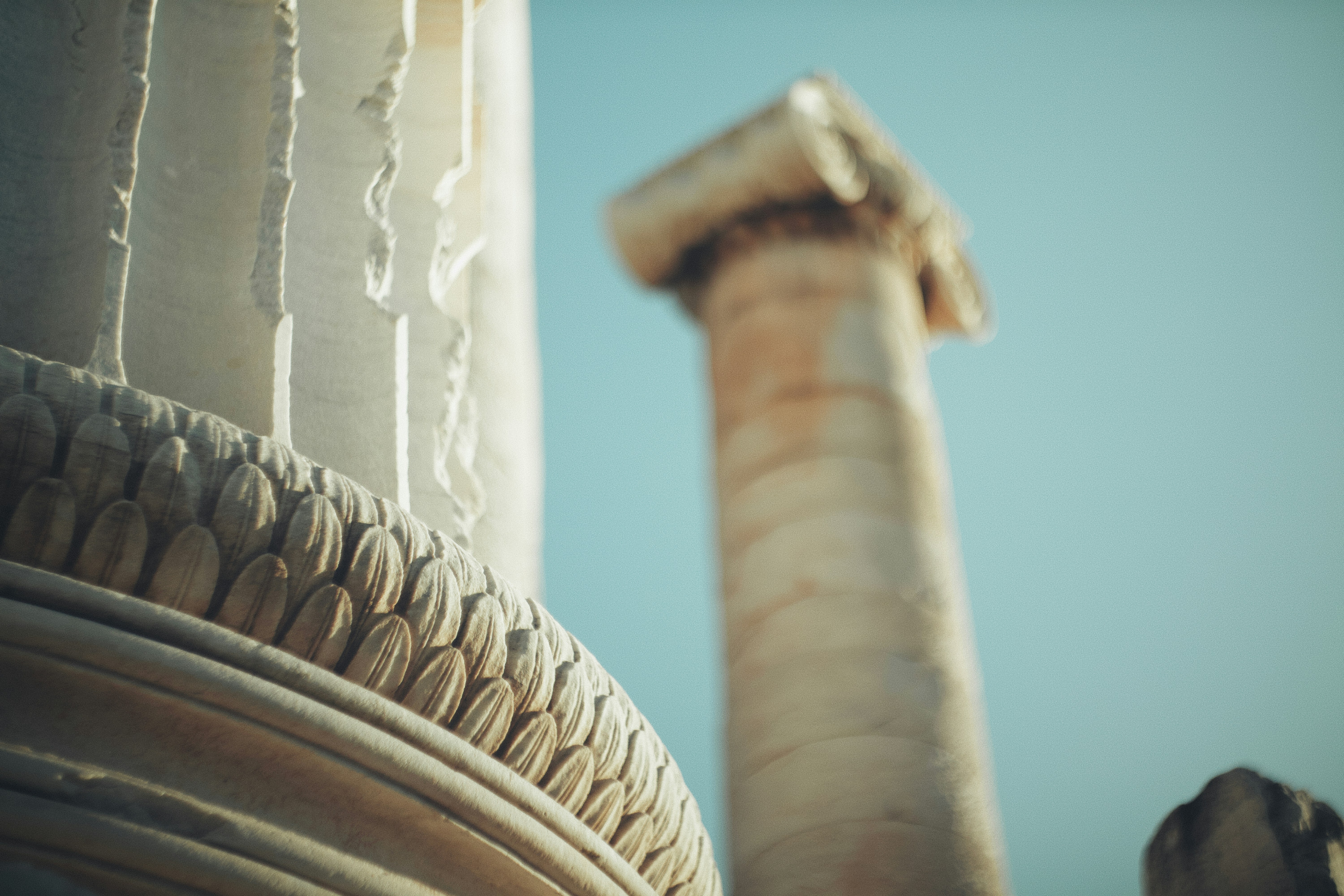 A close up of a stone pillar with a blue sky in the background photo ...