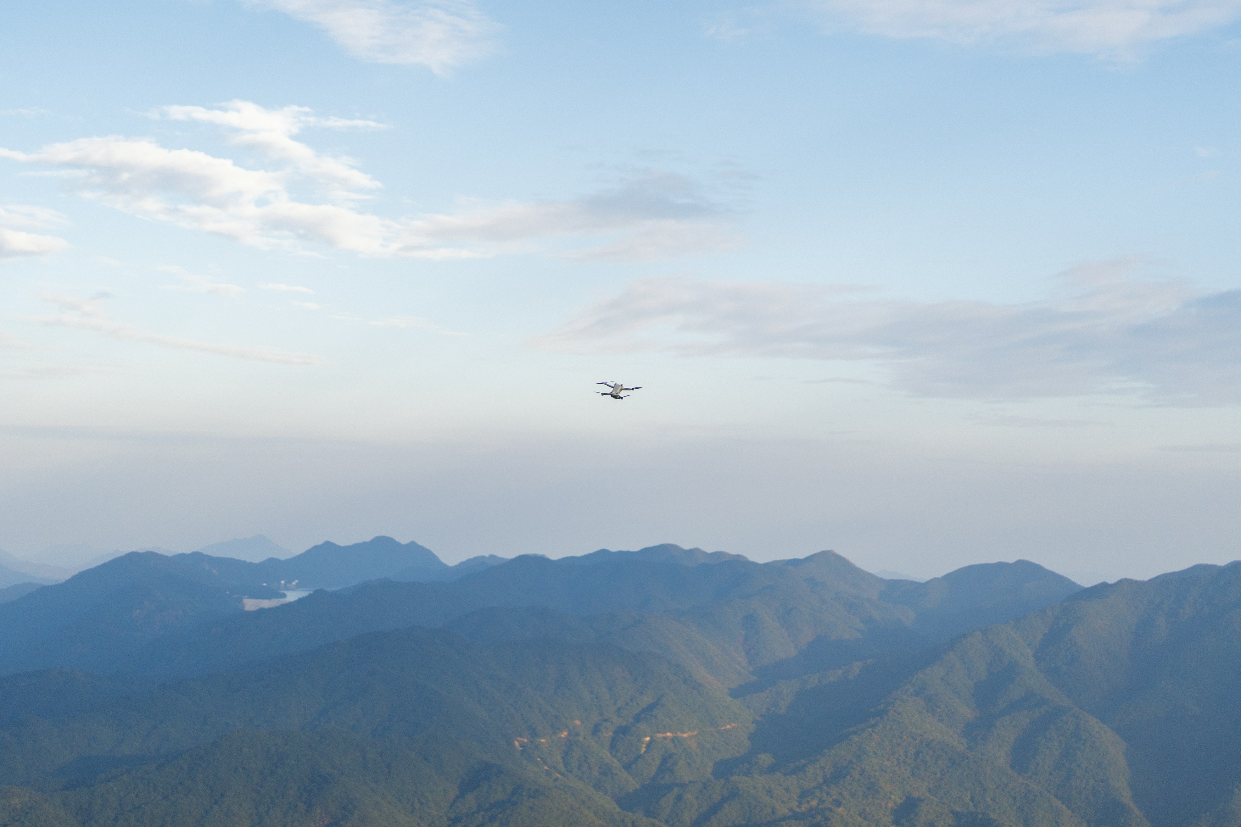An airplane is flying over a mountain range photo – Free Jizhen ...