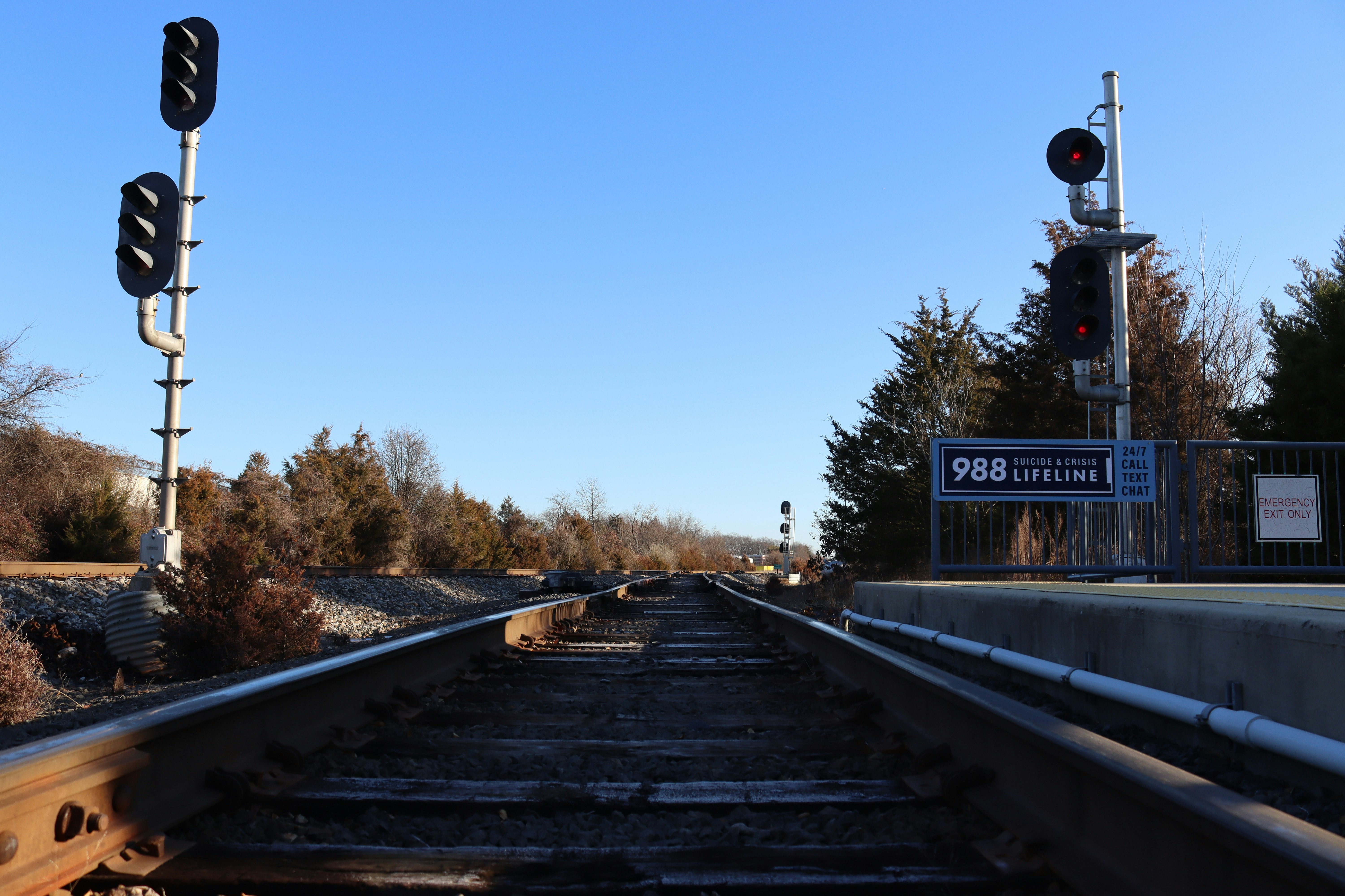 A railroad track with a red light on it photo – Free Railway Image on ...