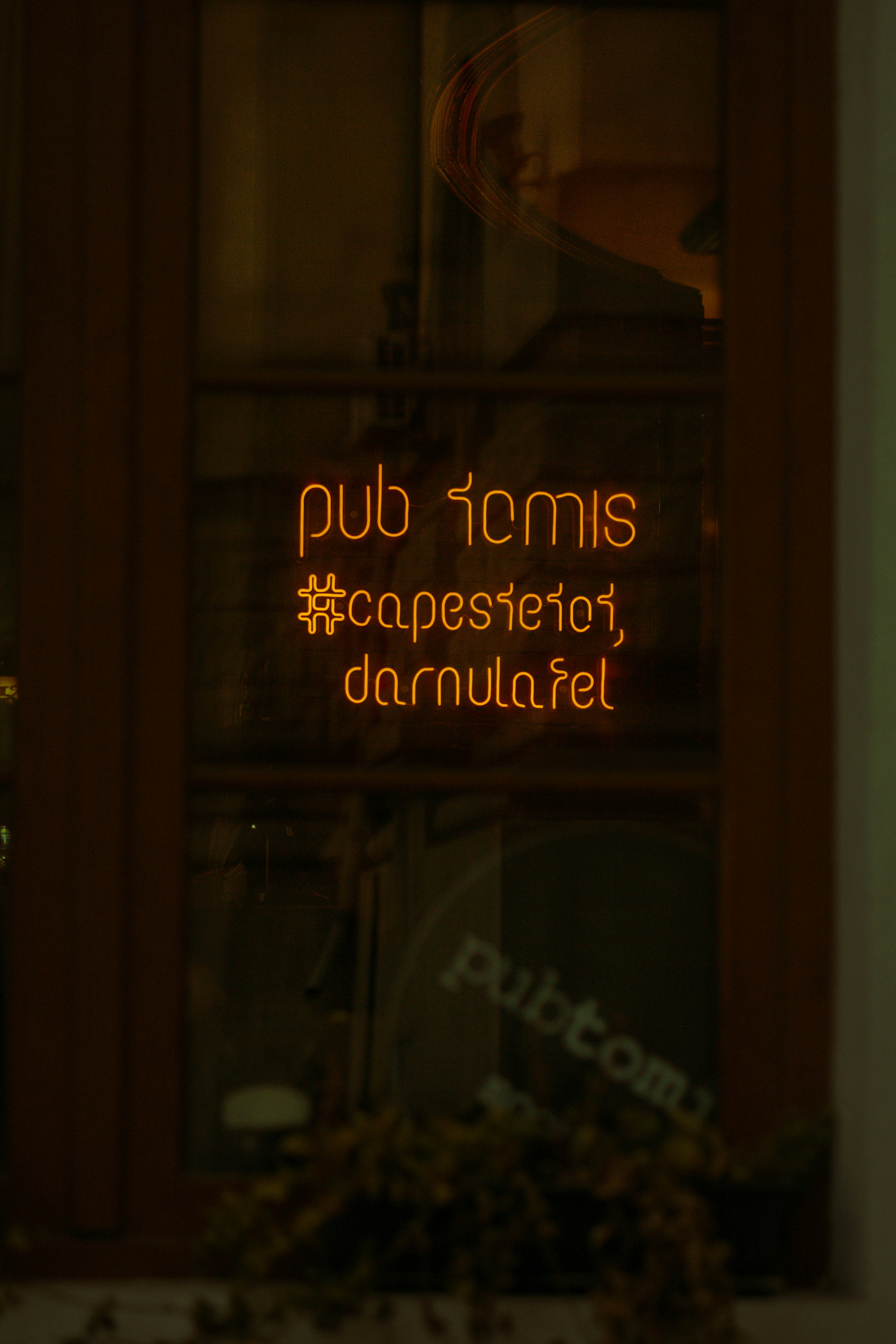 Amber Neon Window Glow: A Dim Pub Sign Portrait