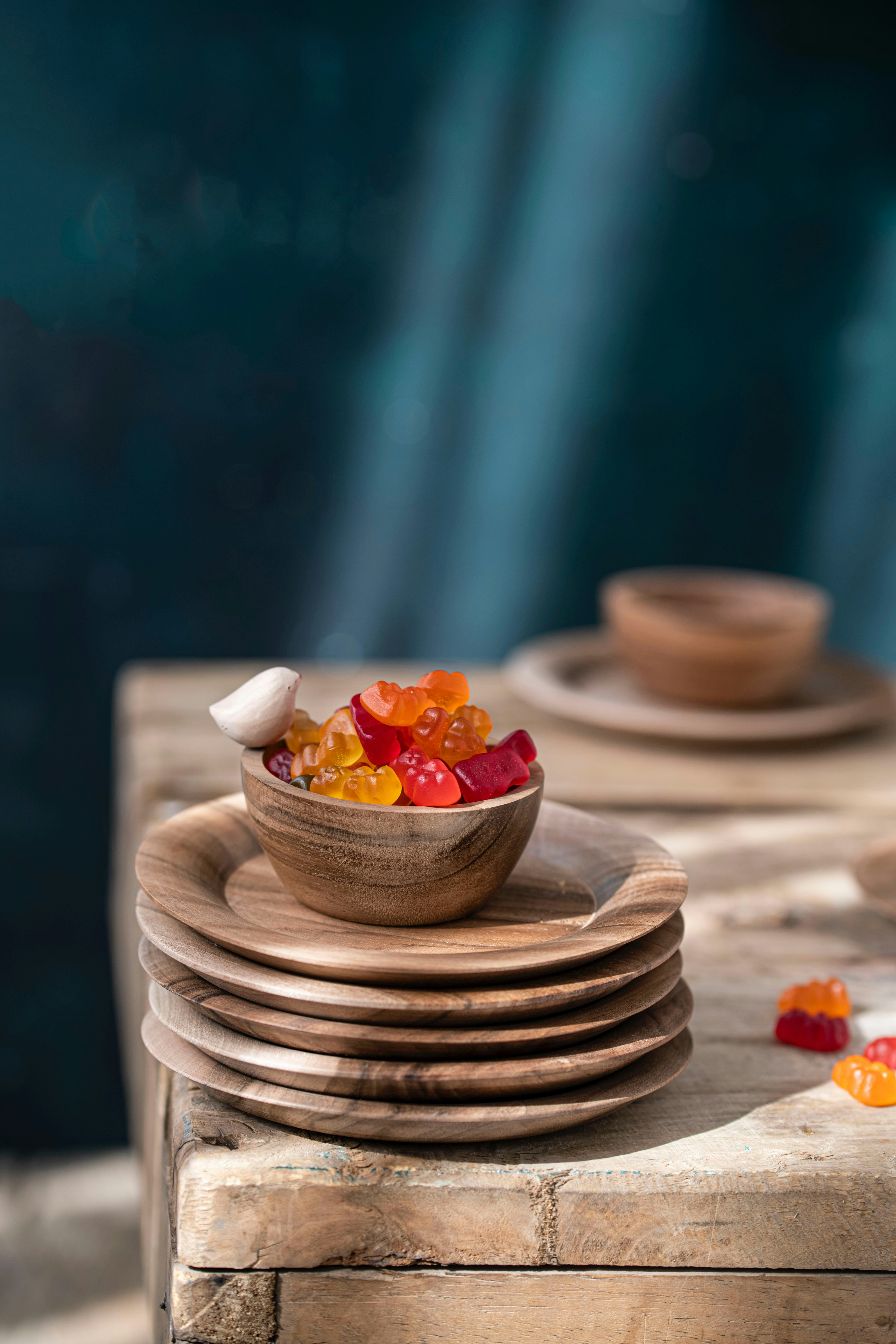 Wooden Bowls of Gummy Jewels on a Weathered Table