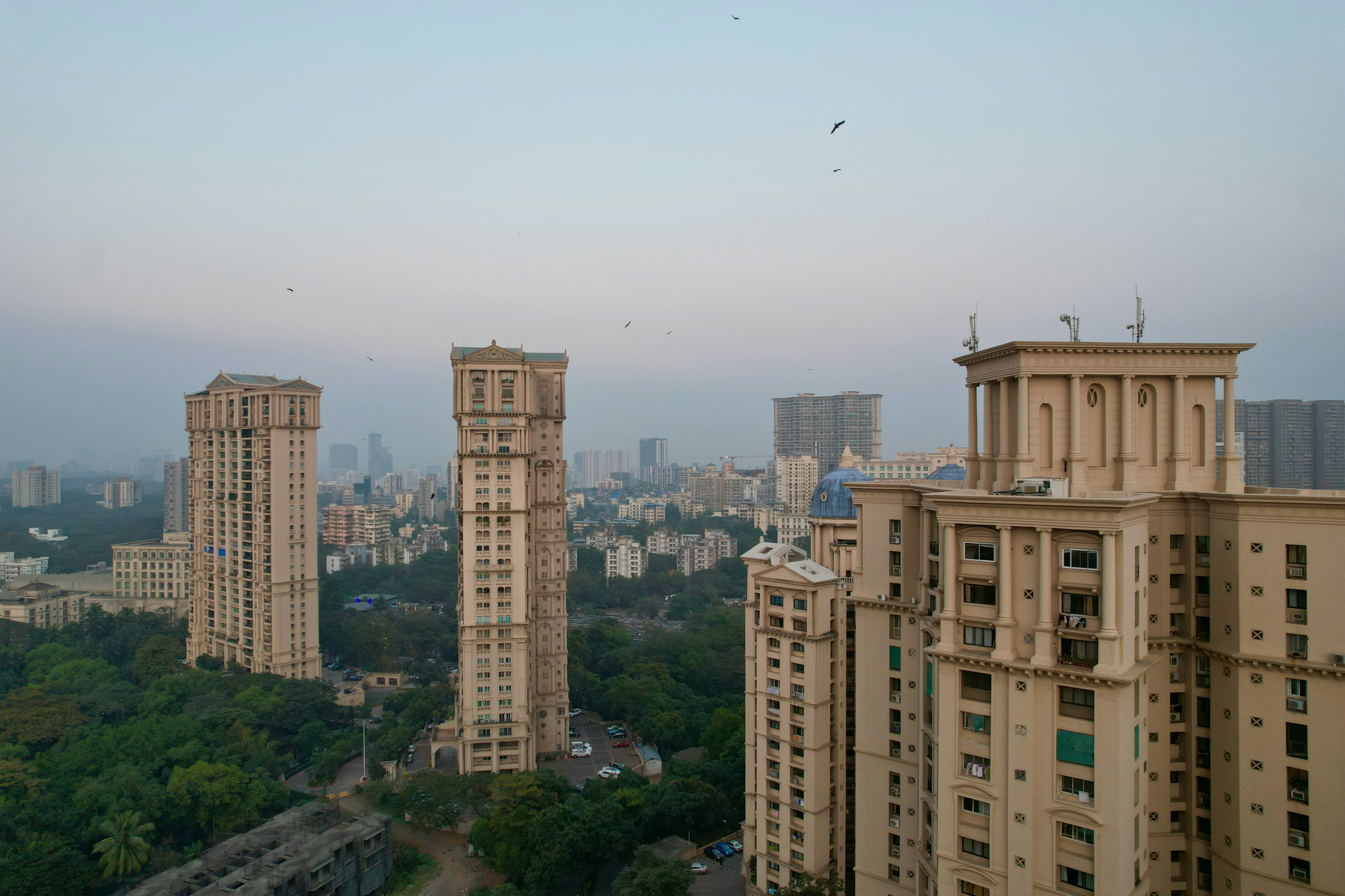 Pictured here are 3 towers of Hiranandani Gardens, a well-known residential and commercial township located in the Powai suburb of Mumbai, India. Developed by the Hiranandani Group, one of the leading real estate developers in the country, the township is renowned for its neoclassical architecture skyscrapers and integrated and sustainable urban planning.