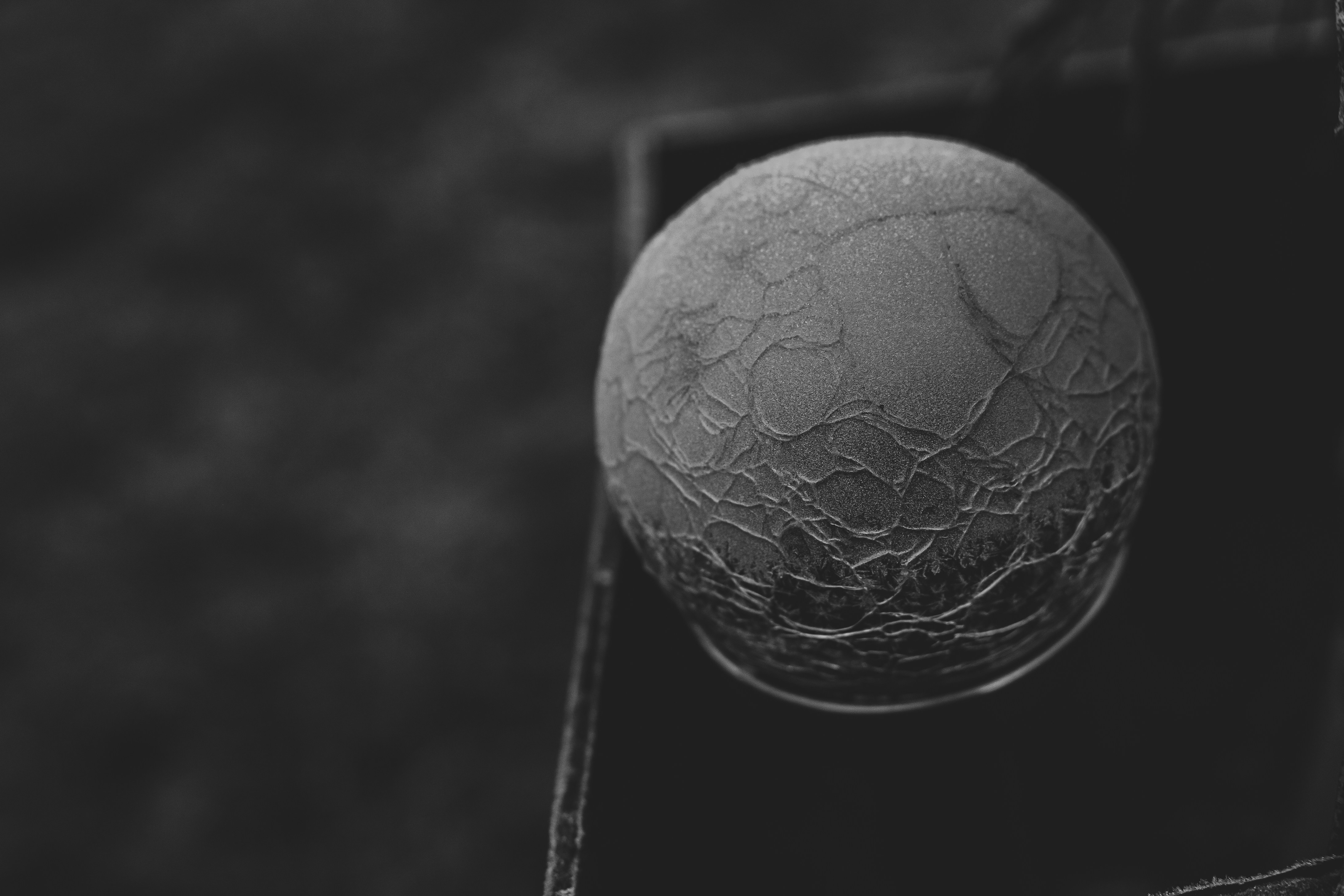 Cracked Globe on a Rustic Shelf: Texture at the Edge of Focus
