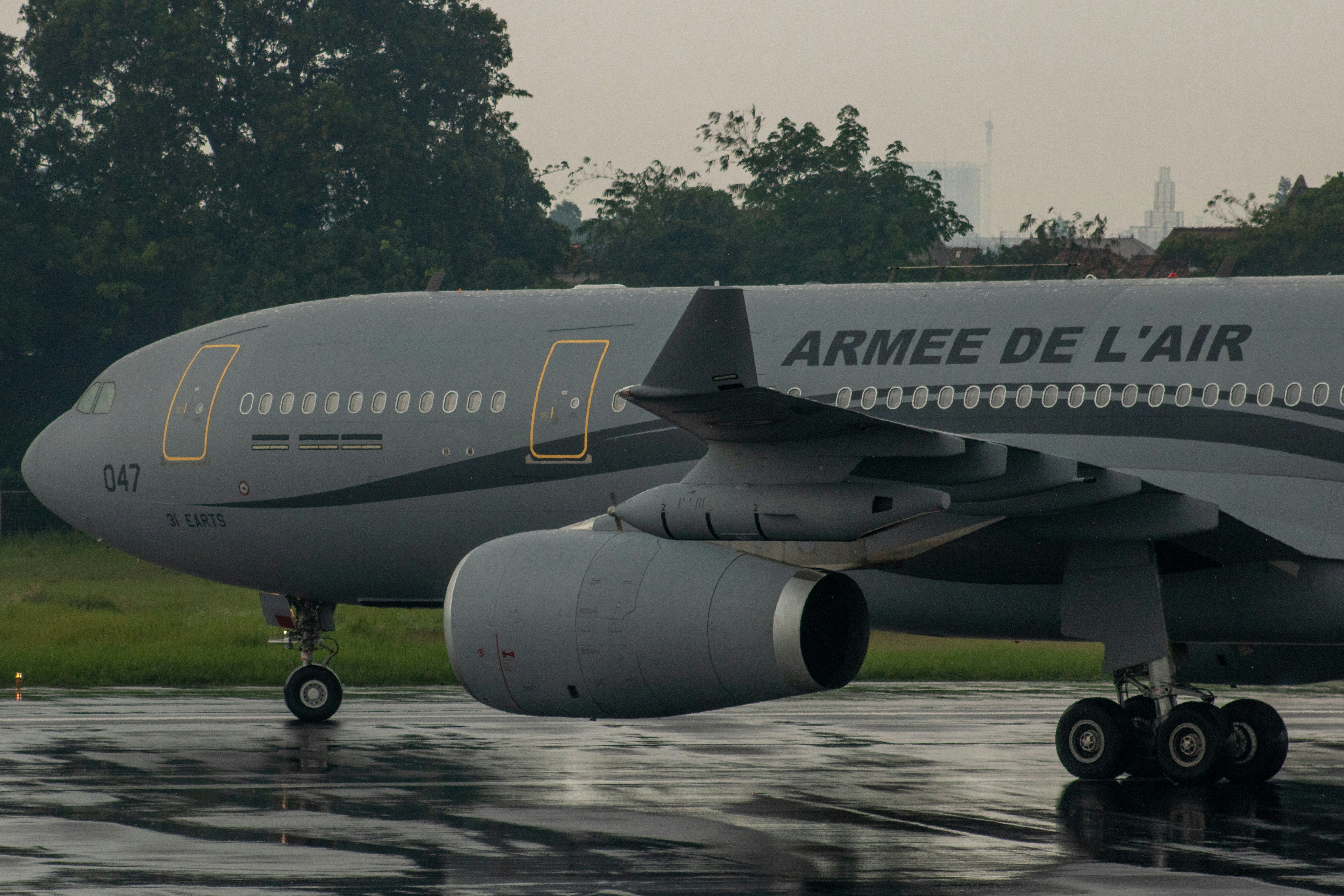 Rain-Kissed Runway Portrait: Left Engine of a French Air Force Airbus
