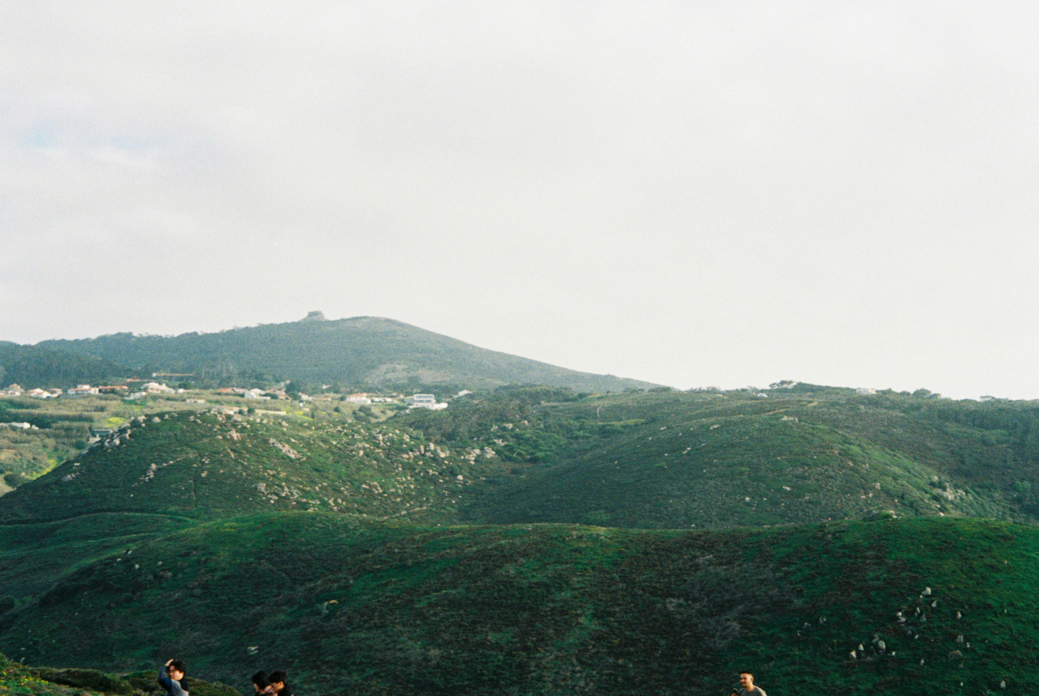 Hushed Hills: Green Ridges Under a Quiet Sky