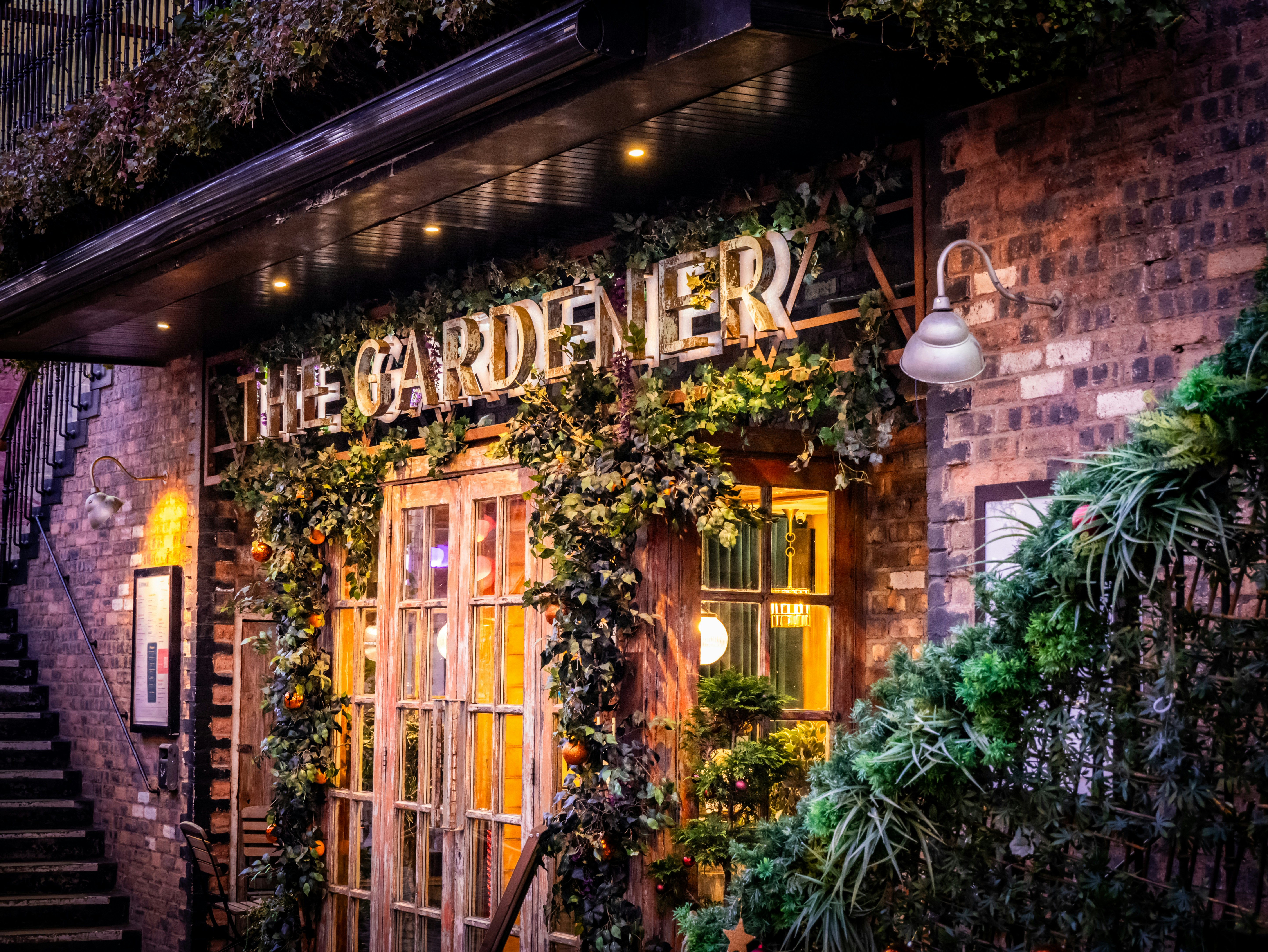 A building that has a bunch of plants on it photo – Free Ashton lane ...