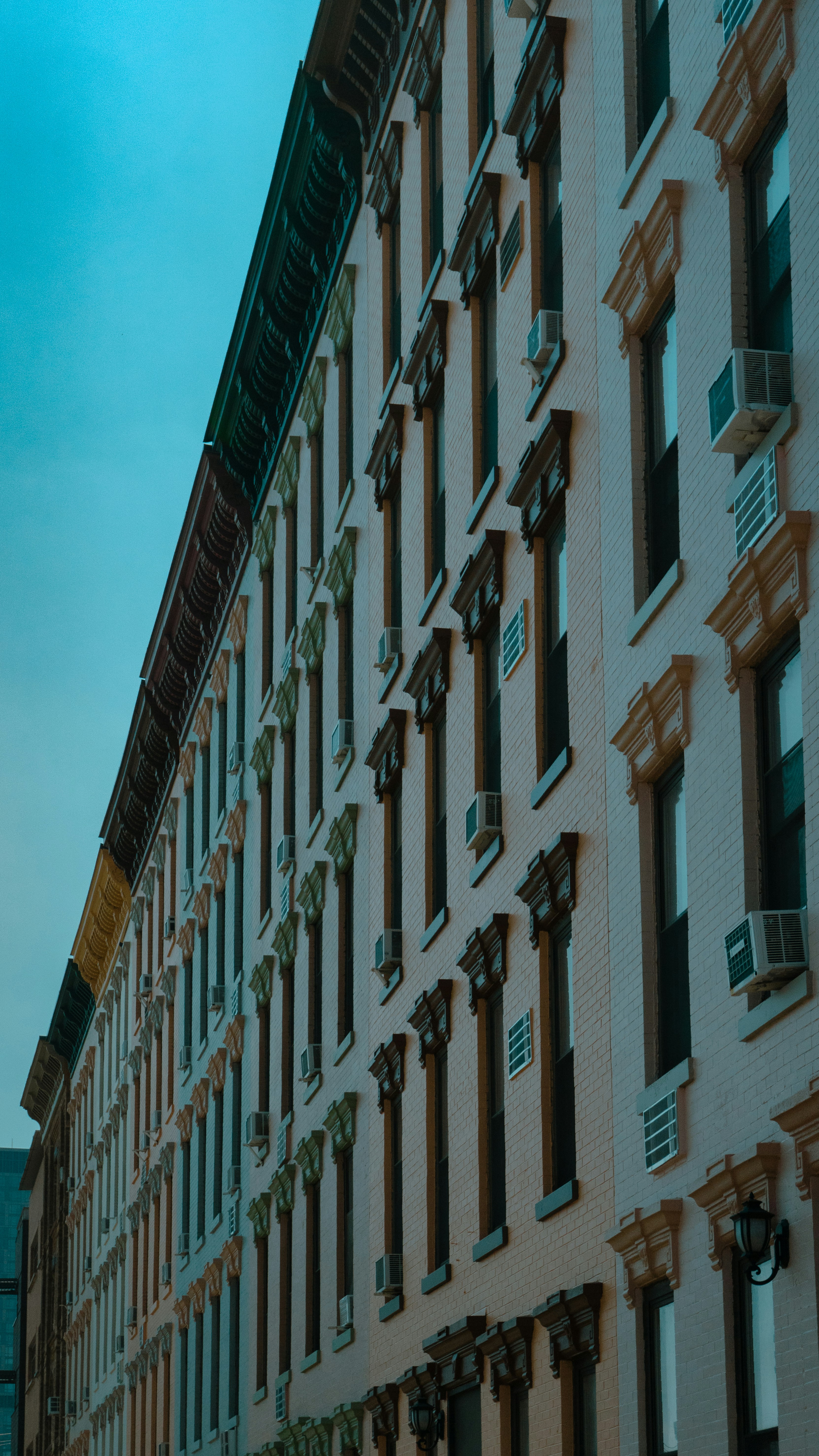 A close-up view of a row of historic buildings showcasing intricate architectural details and colorful cornices.