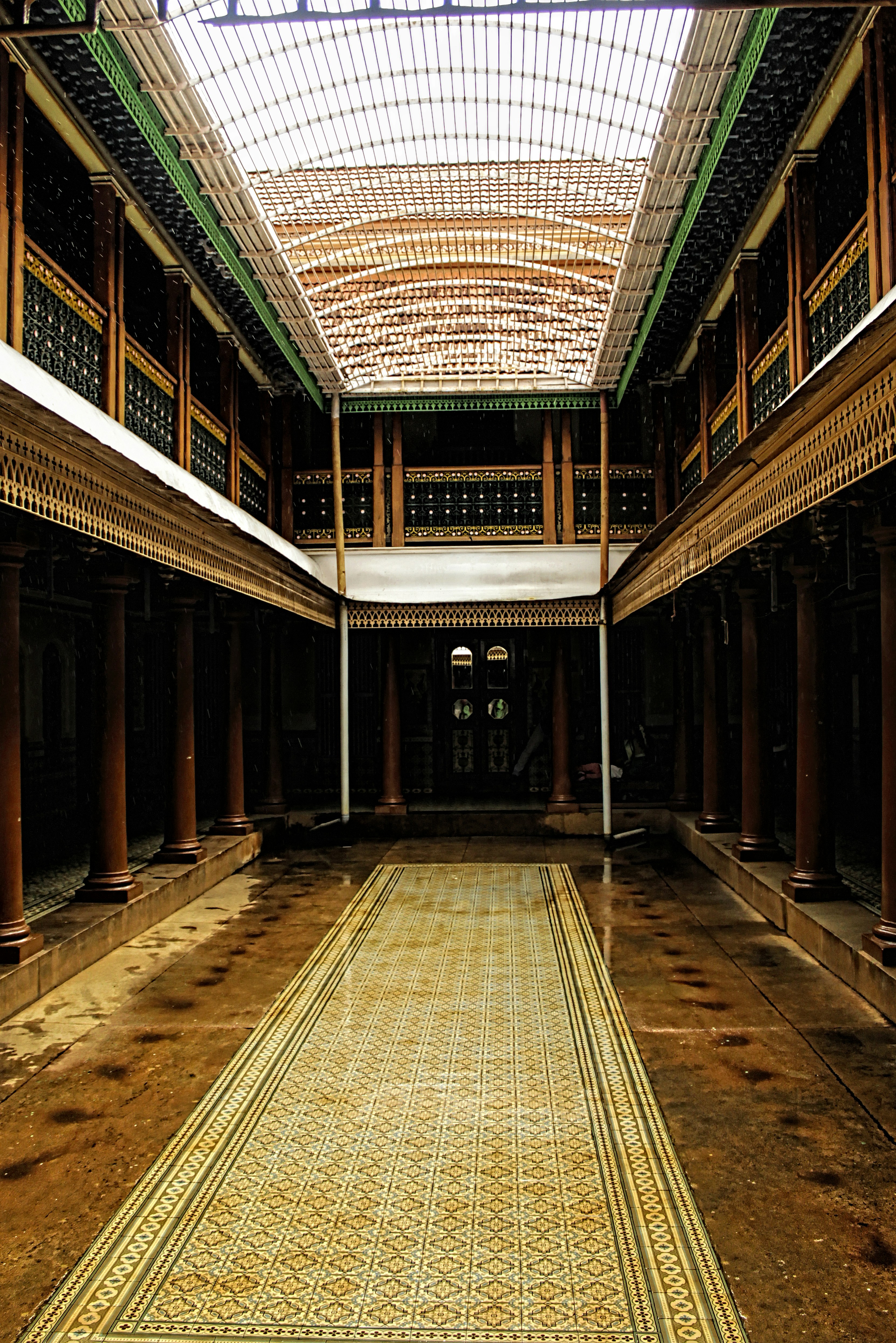 Lanterned Sky over a Golden Corridor of Carved Columns