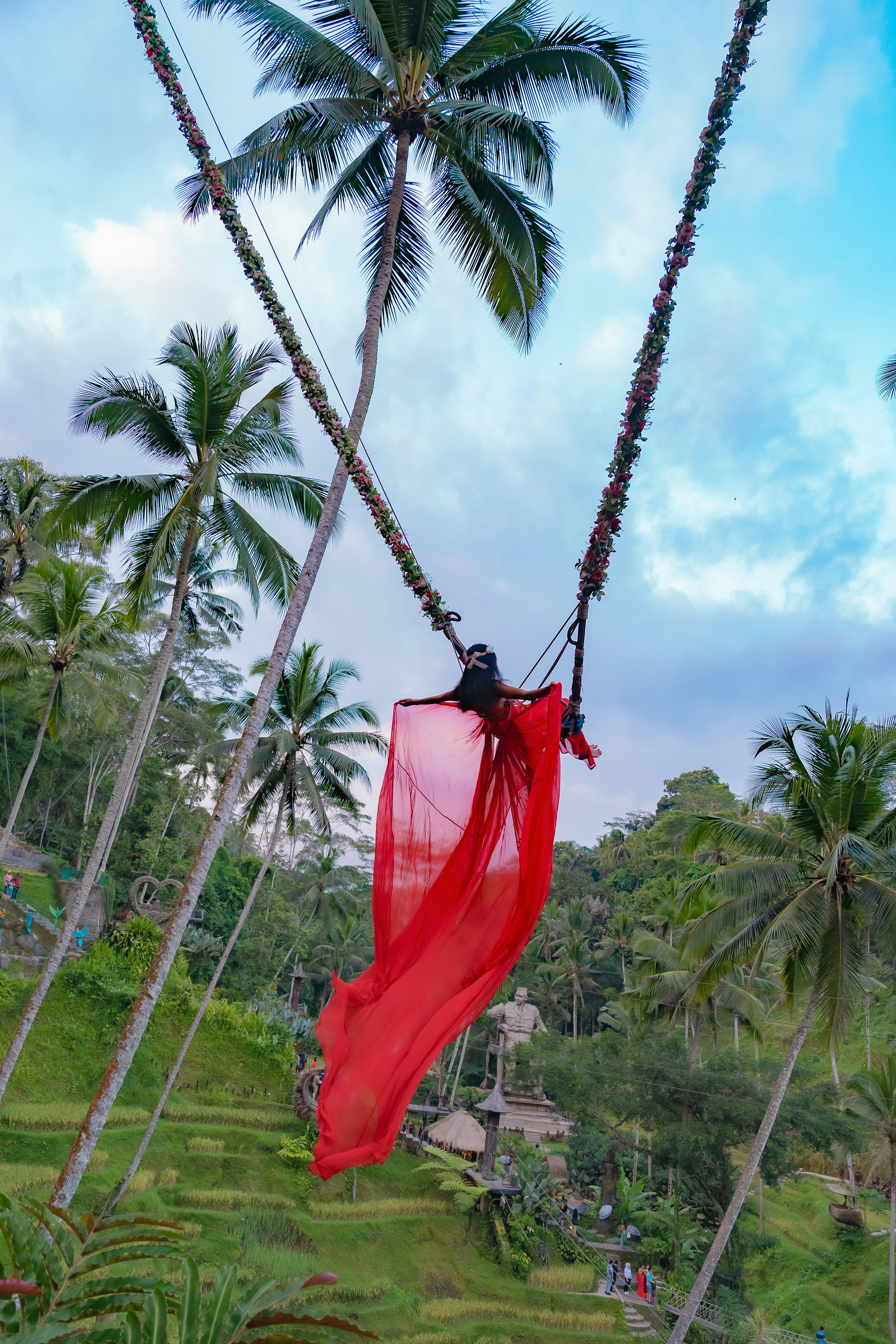 Crimson Silk Soars Above a Palm-Lined Terrace